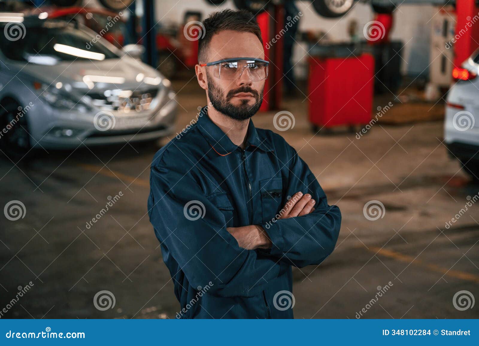 Standing and Posing. Car Repairman is in the Garage with Automobile ...