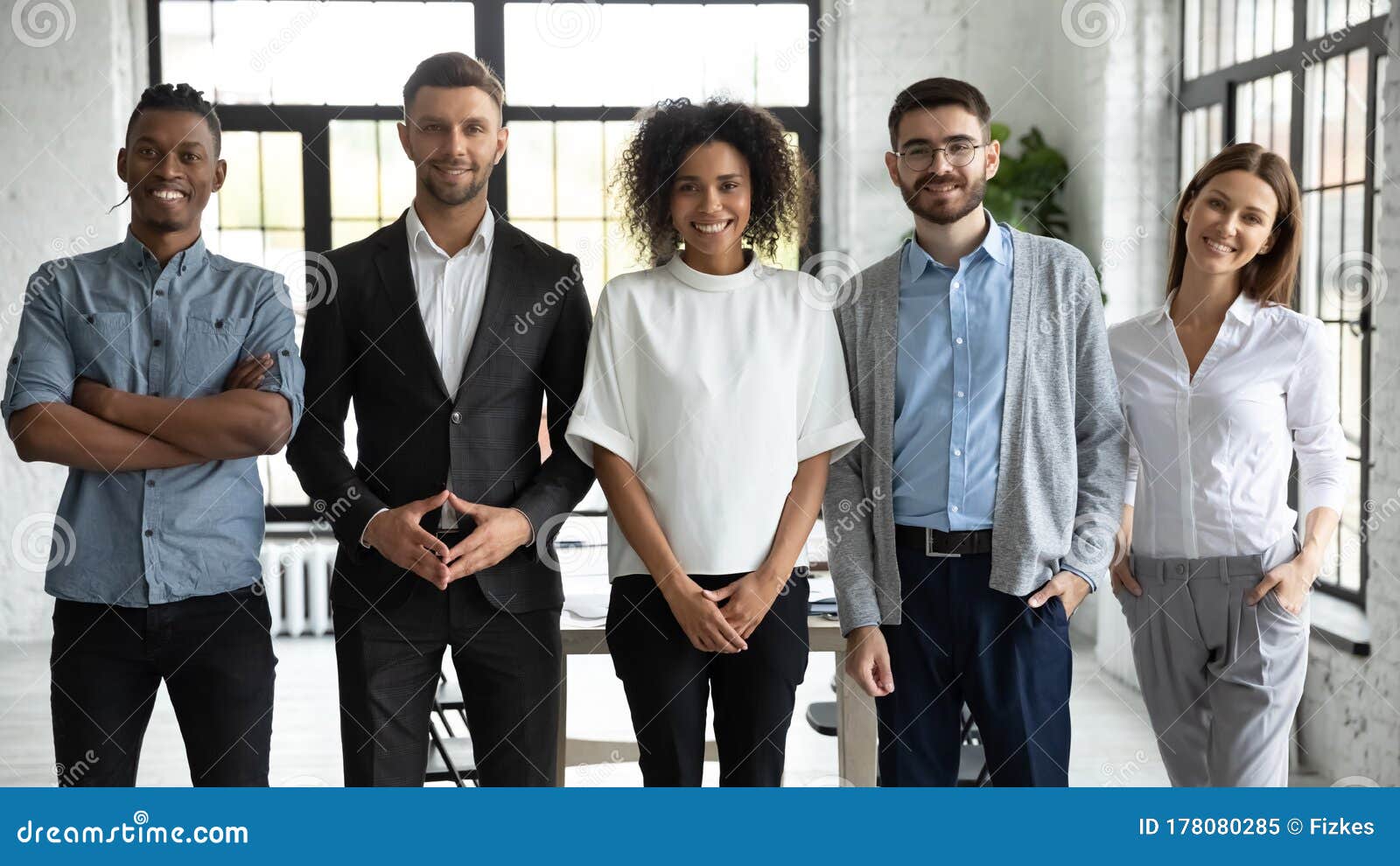 Standing in Row Smiling Diverse Team Posing Differently. Stock Image ...