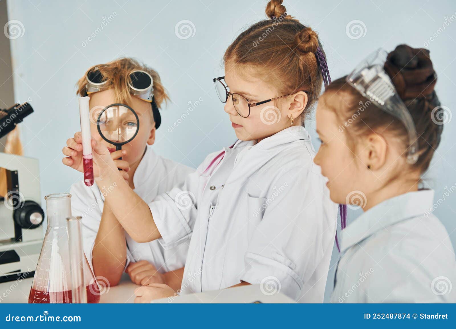 Standing by the Table with Test Tubes. Children in White Coats Plays a ...