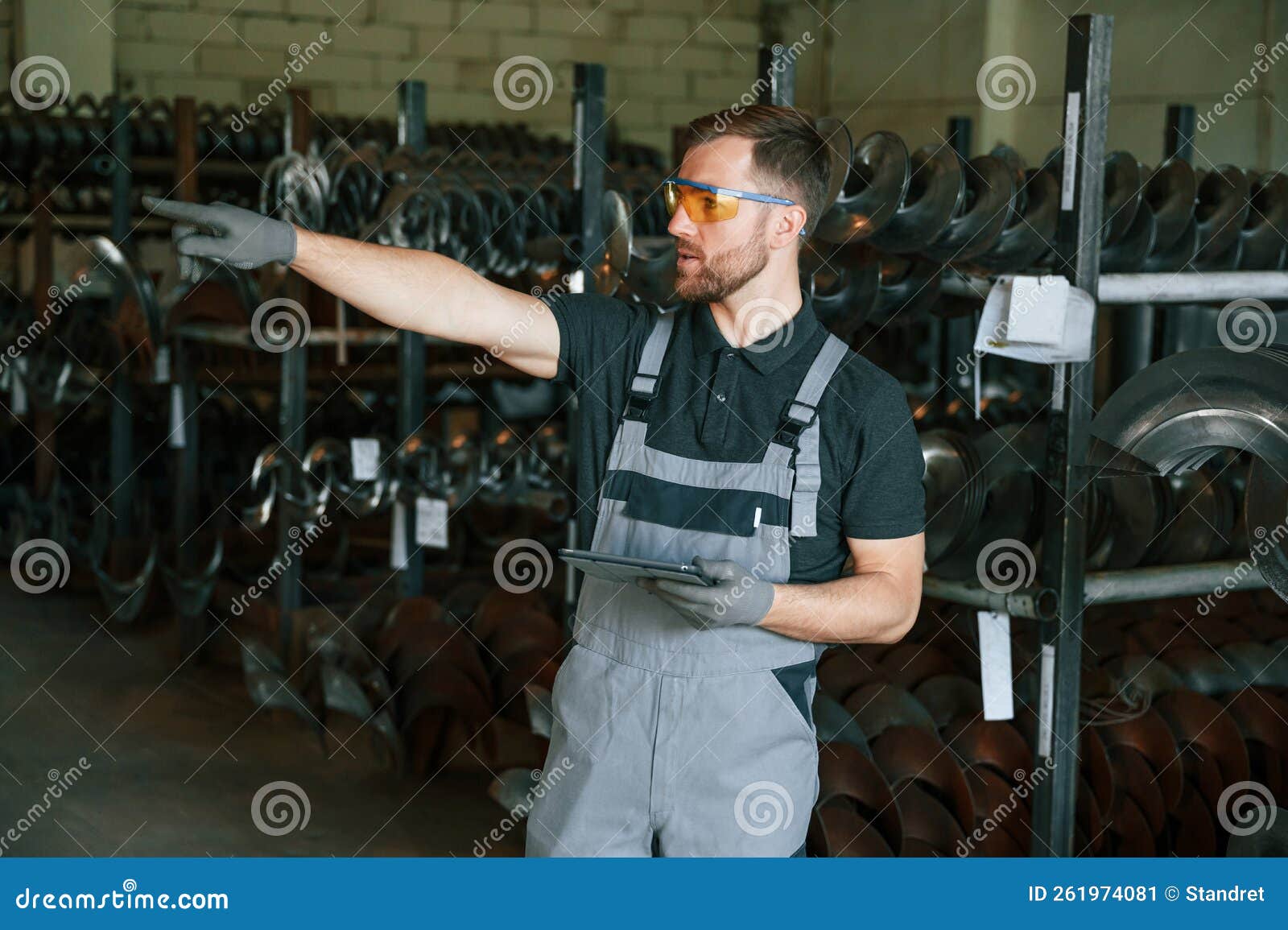 Standing with Tablet. Man in Uniform is in Workstation Developing ...