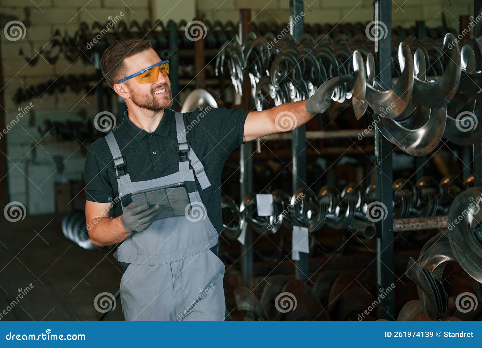 Standing with Tablet. Man in Uniform is in Workstation Developing ...