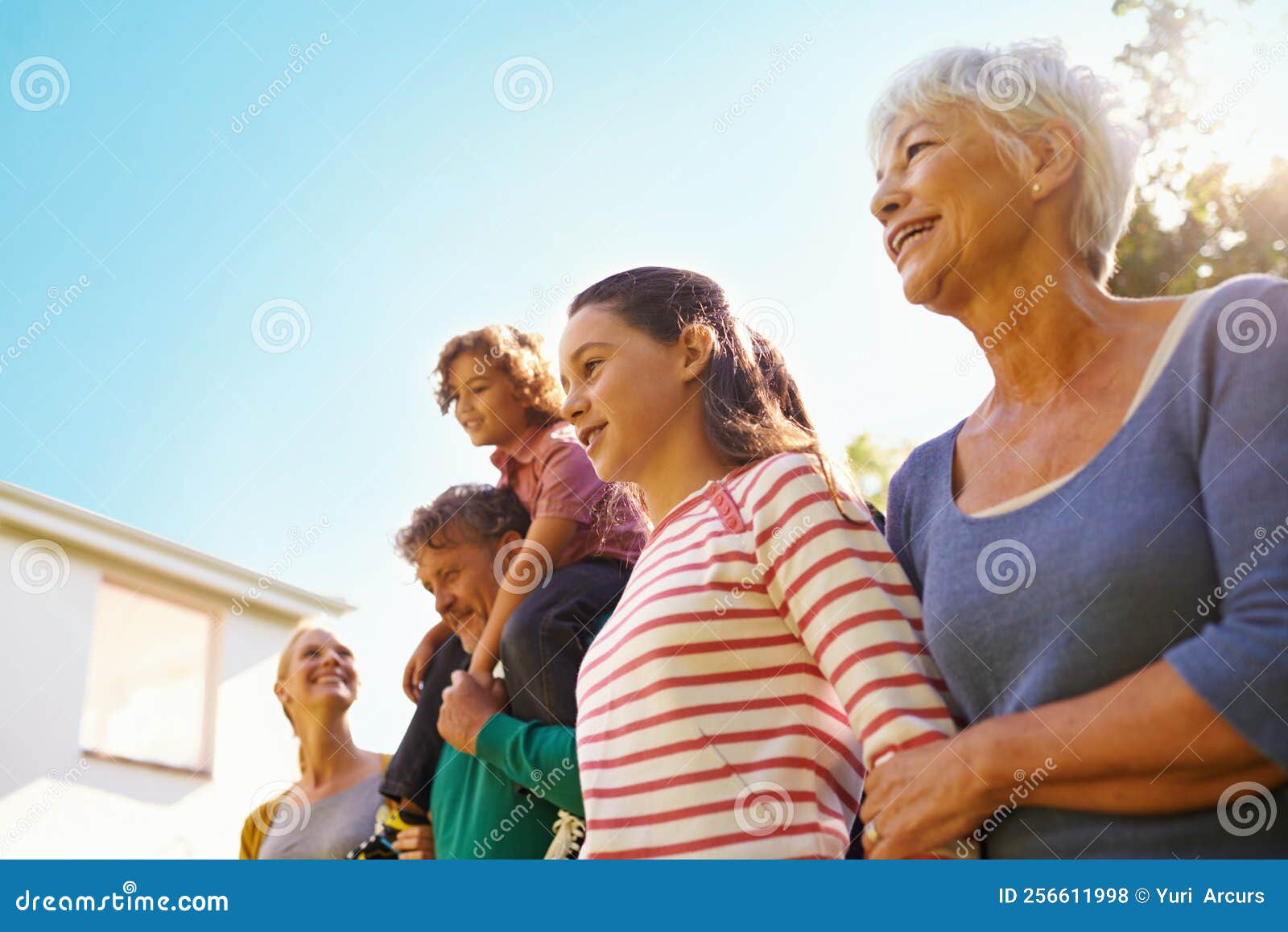 Standing Together As a Family. Low Angle Shot of a Family Outdoors ...