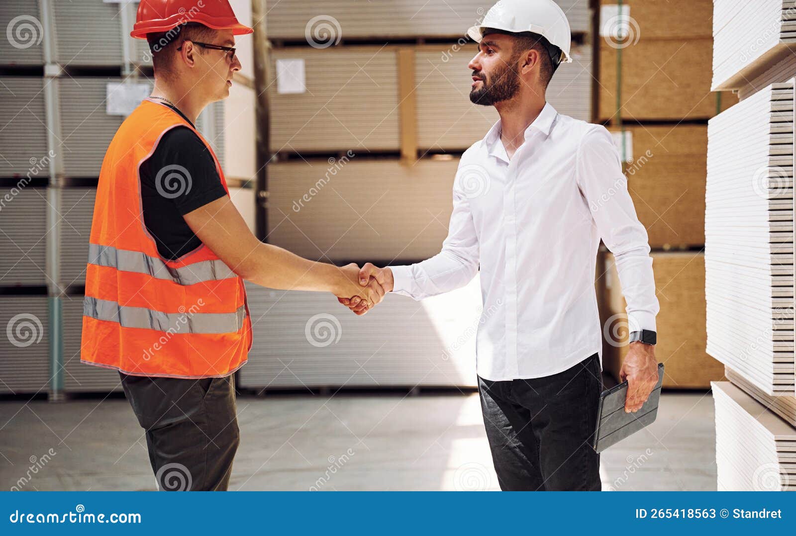 Standing Together. Two Storage Workers is in the Warehouse Stock Image ...