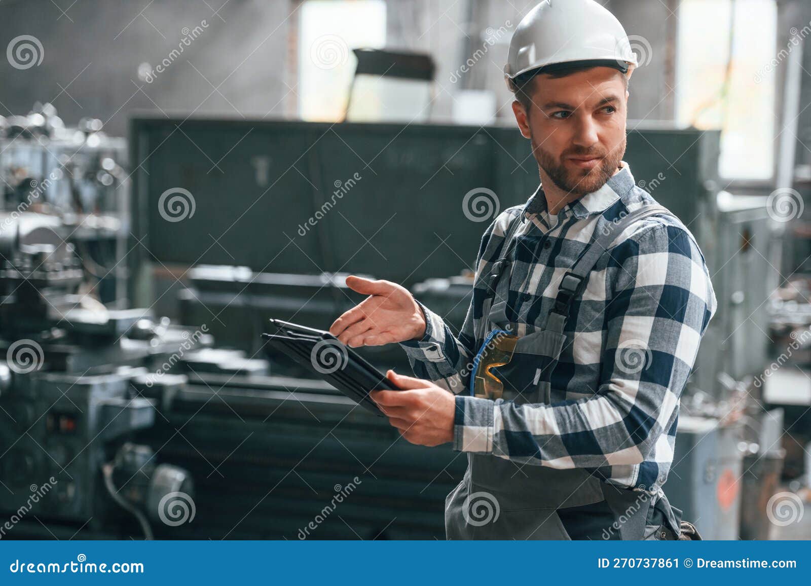 Standing and Using Graphic Tablet. Factory Male Worker in Uniform is ...