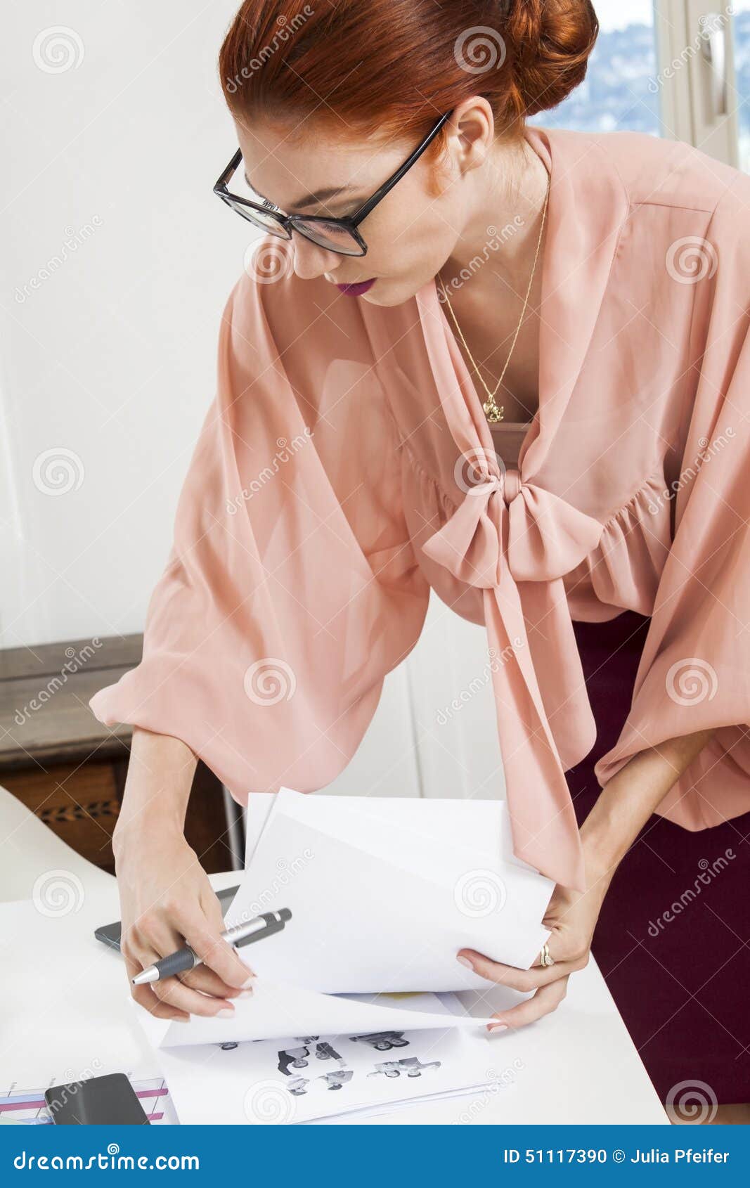 Standing Young Office Woman Writing on a Desk Stock Photo - Image of ...