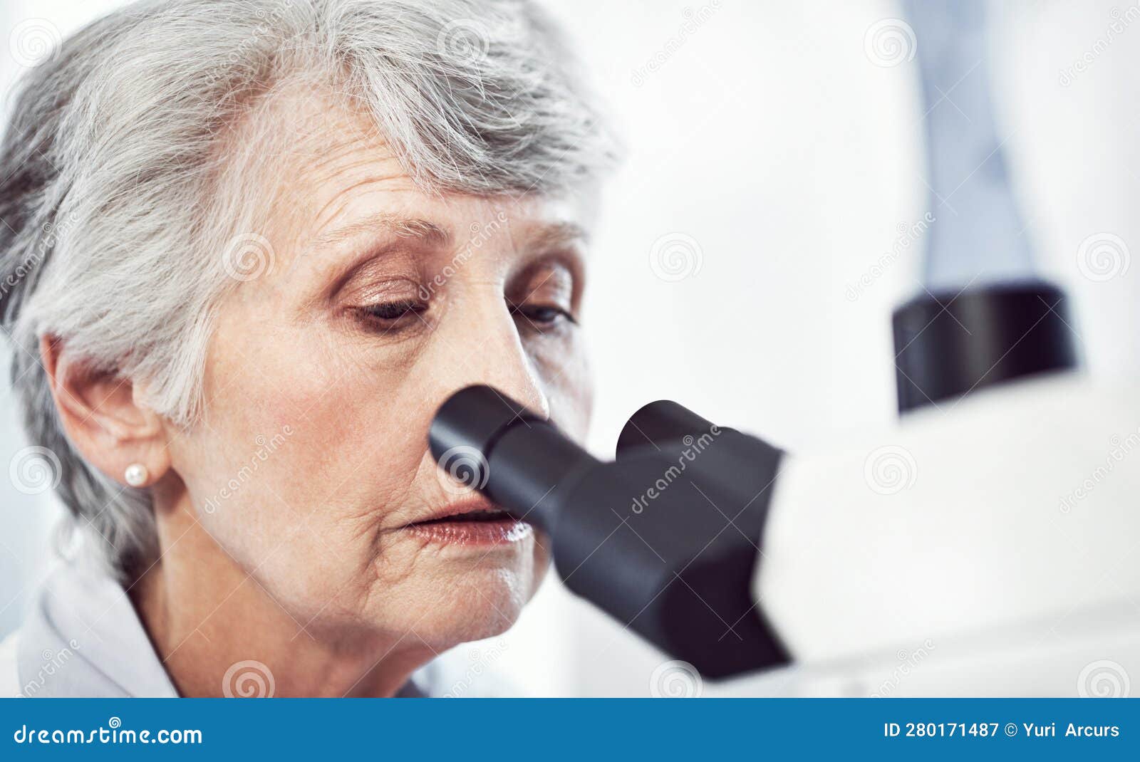 Staring into the Experiment. a Focused Elderly Female Scientist Looking ...