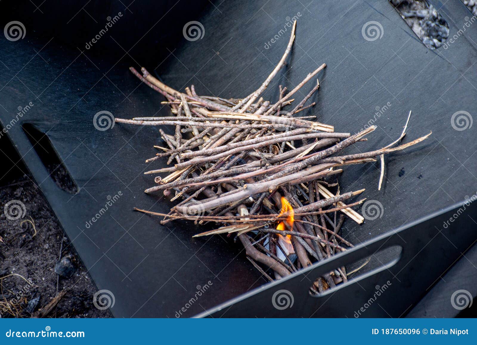 Starting the Camp Fire with Kindling in a Portable Firepit Stock Photo ...