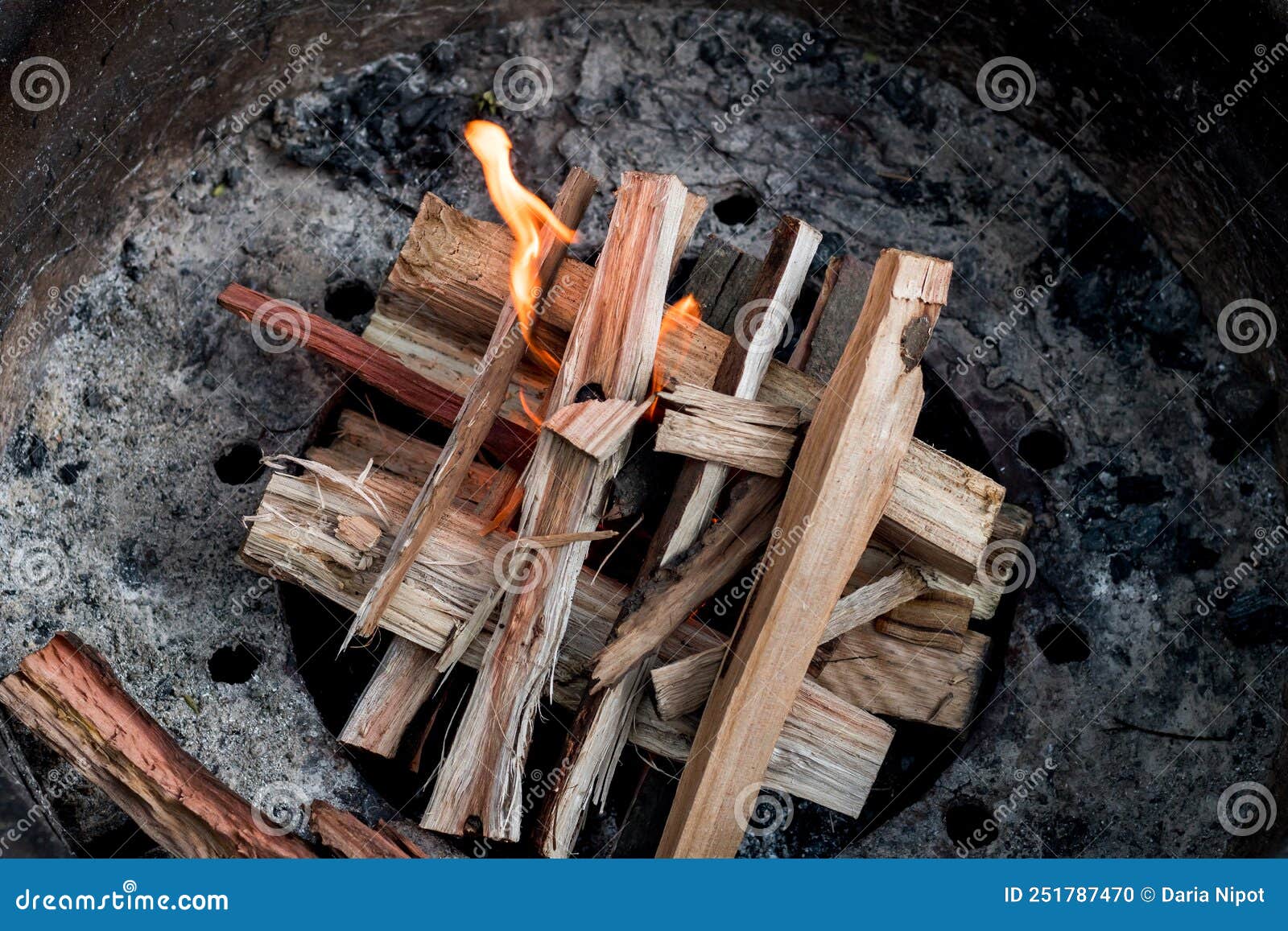 Starting a Campfire in a Firepit with Kindling. Camping Lifestyle Stock ...