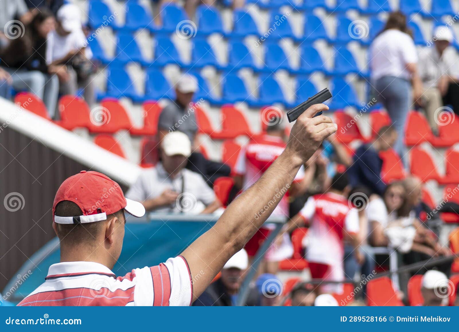 Starting Pistol in a Man& X27;s Hand at the Stadium. Start of Running ...
