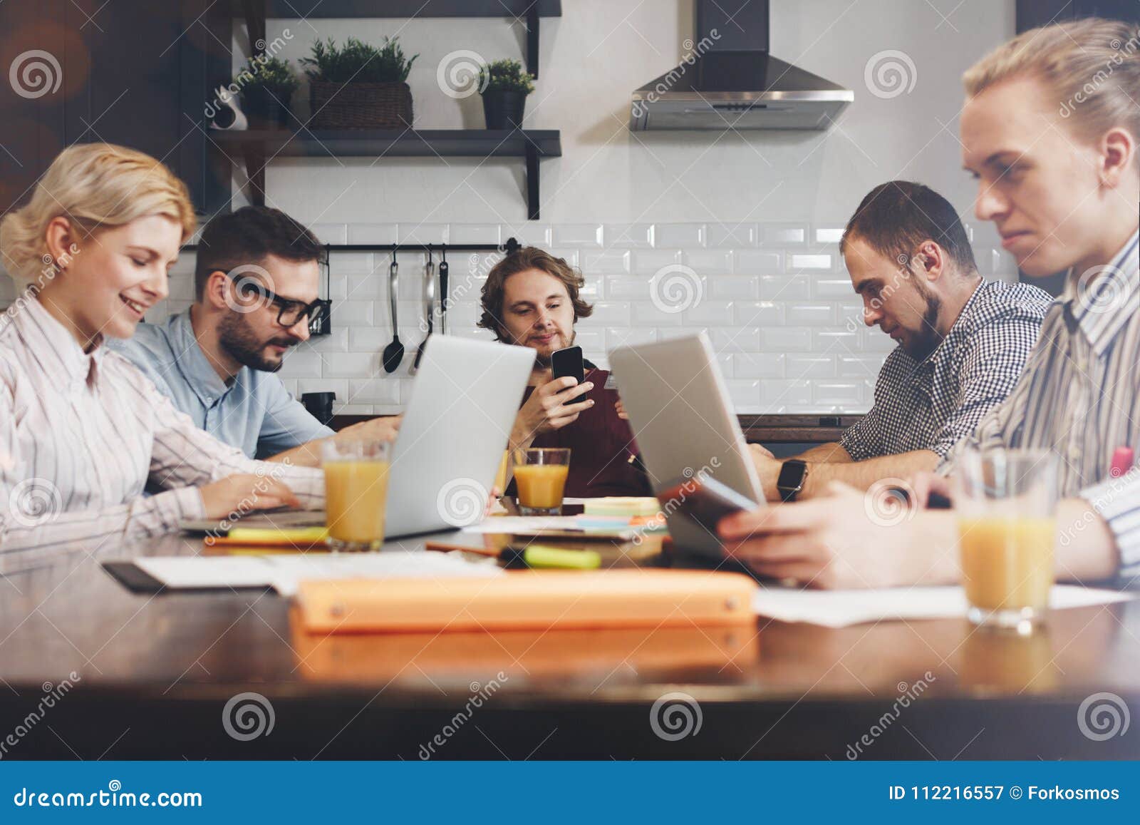Startup Team Sitting Together at Table Using Laptop in Class. Yo Stock ...