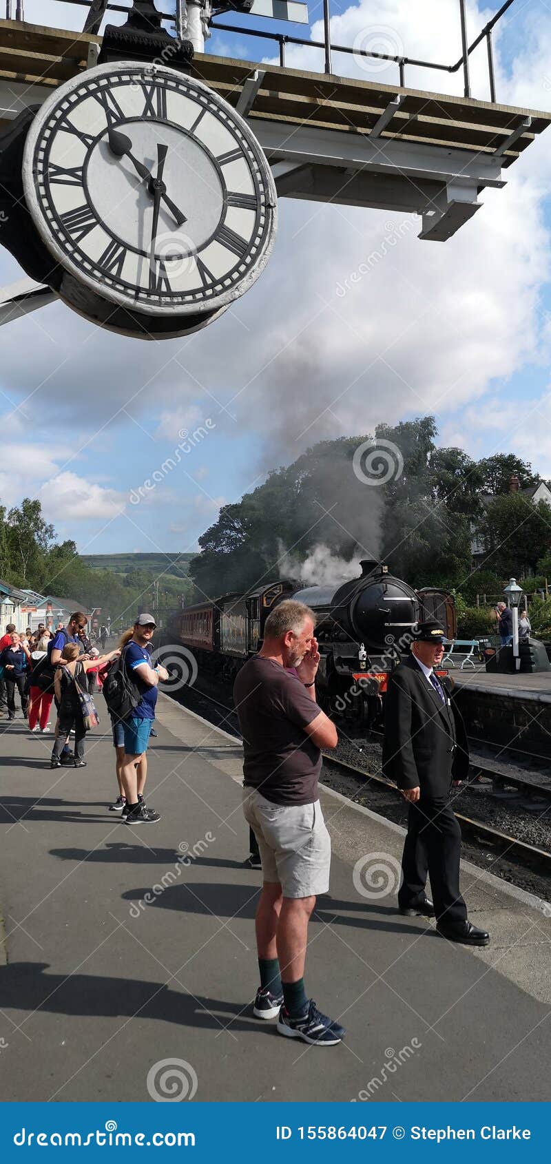 Station Clock with Steam Train at Platform Editorial Photography ...