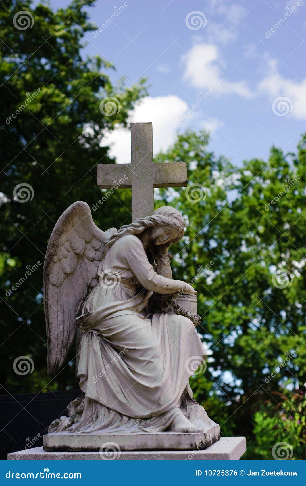 Statue of an Angel with Cross Stock Photo - Image of grass, funeral ...