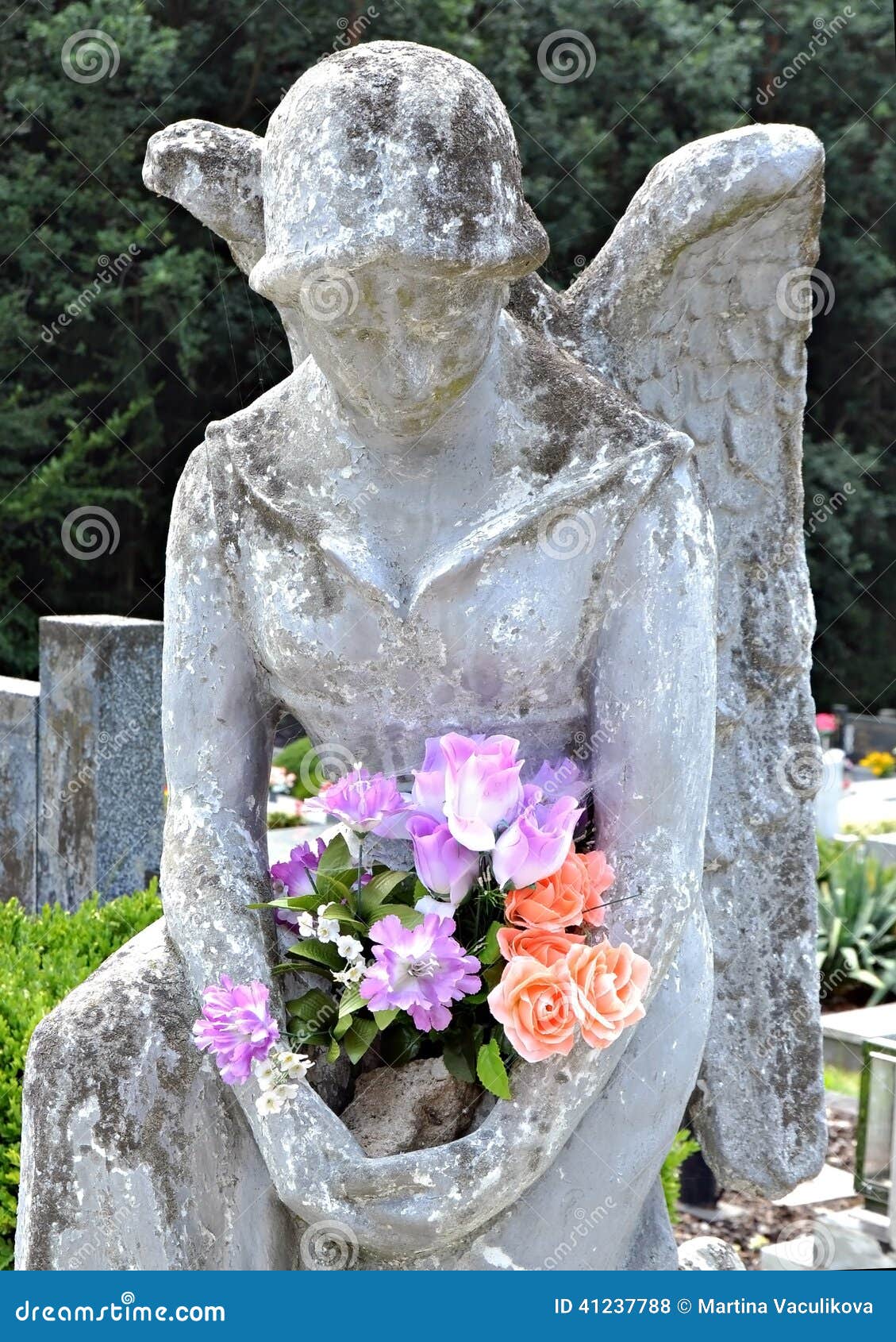 Statue of an Angel Holding Flowers Stock Photo - Image of garden ...