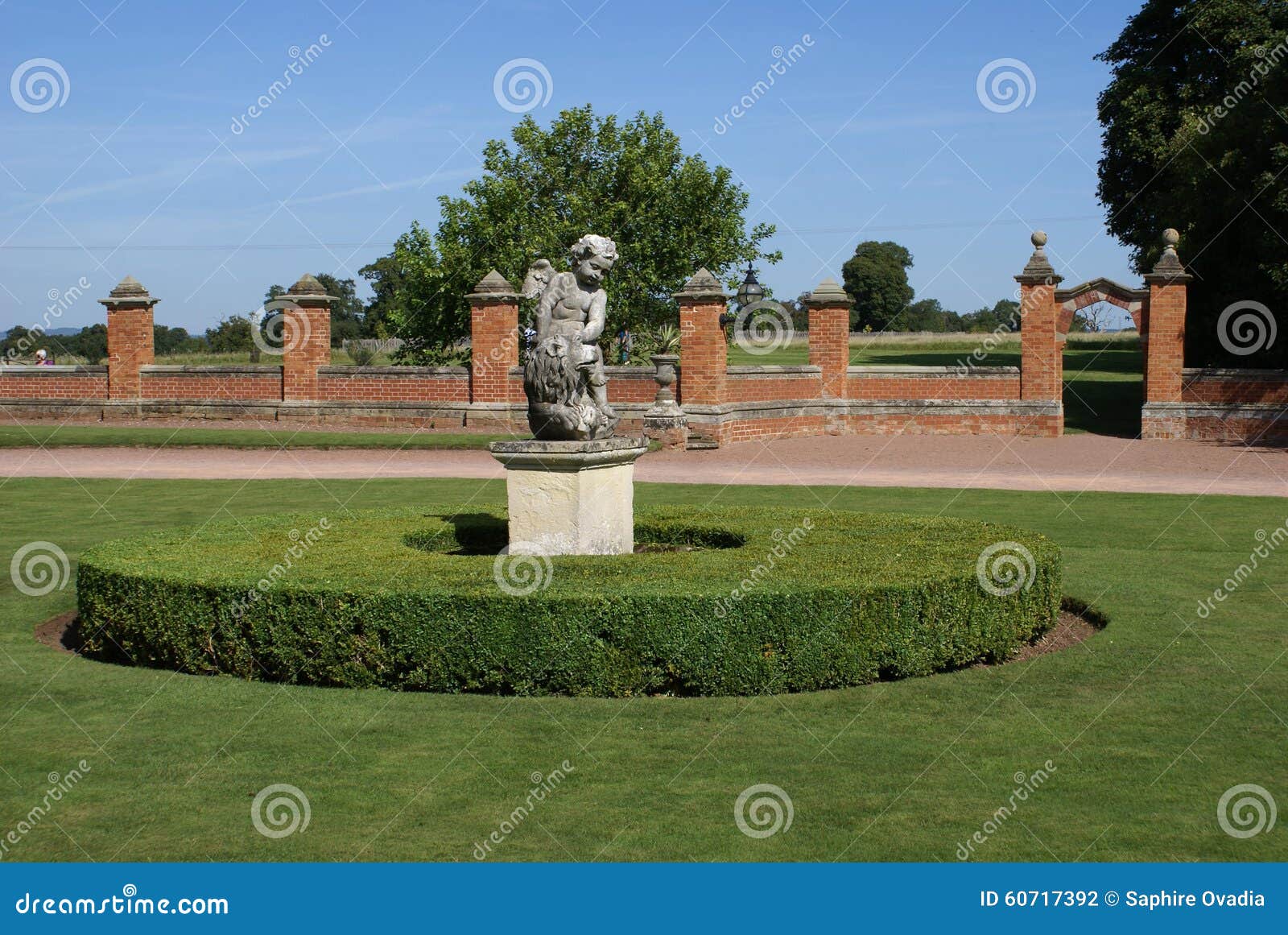 Statue of an Angel on a Lion and Hedge Stock Photo - Image of circular ...