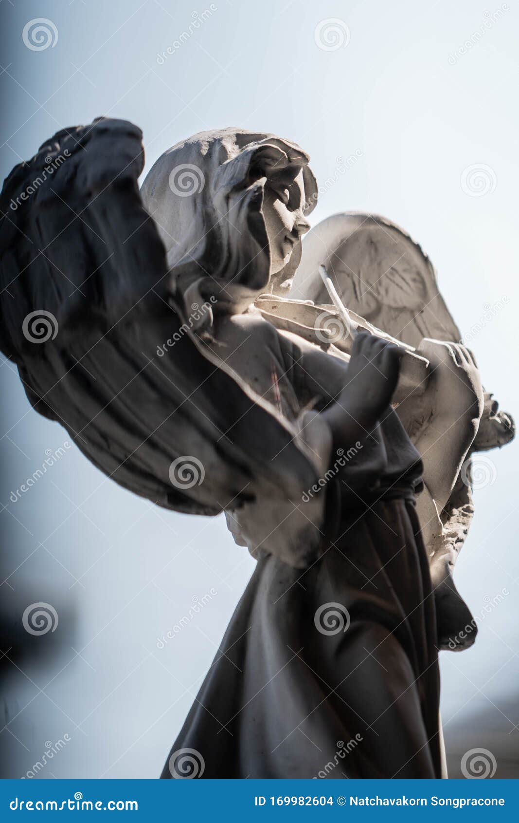 Statue of an Angel Playing Violin in the Garden Stock Photo - Image of ...