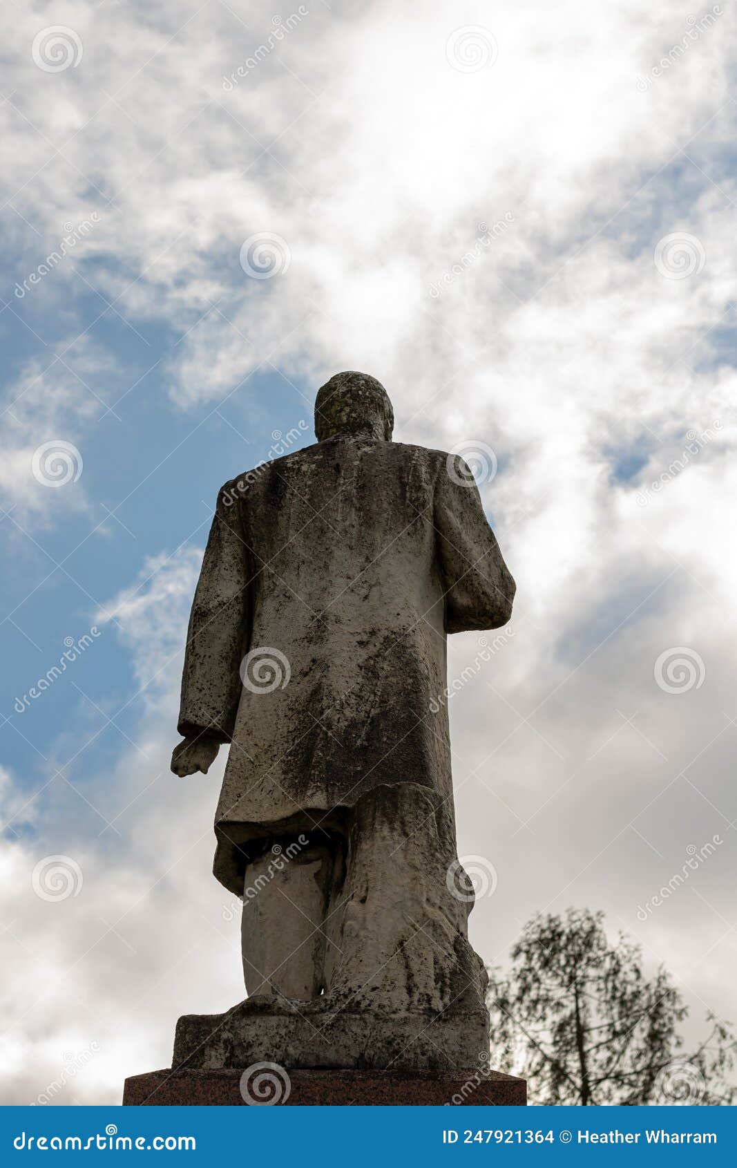 Statue of Back of Man, One Arm Folded Against Blue Cloudy Sky. Stock ...