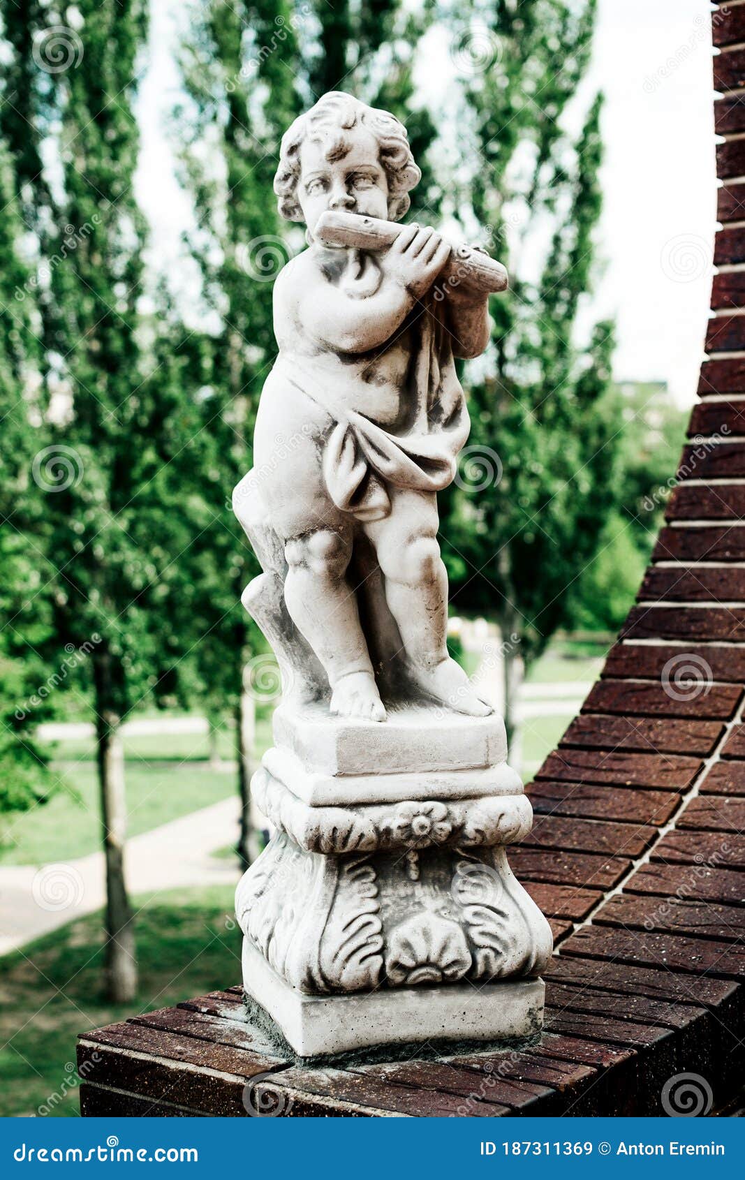Statue of a Boy on a Brown Stone Wall Stock Image - Image of landmarks ...