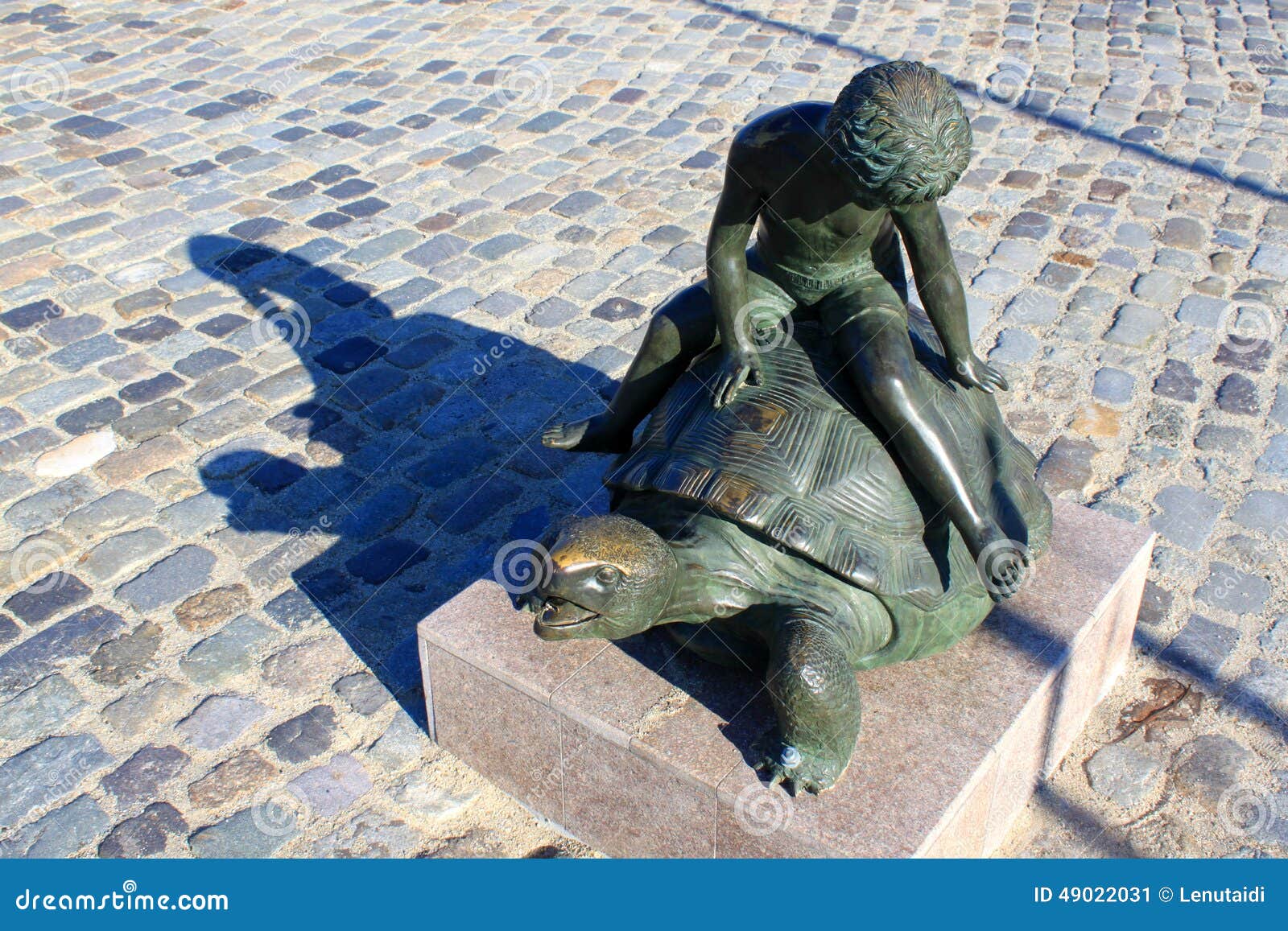 Statue of Boy Riding Turtle Stock Image - Image of pavement, statue ...