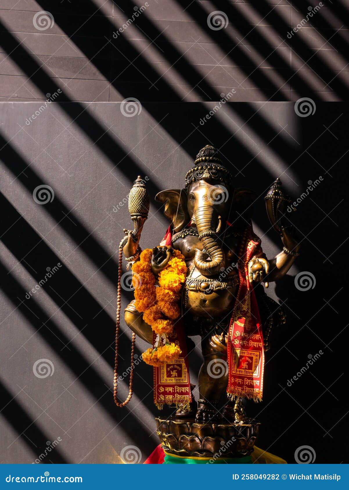 Statue of Brass Ganesha Standing Behind the Shadow Lines Stock Photo ...