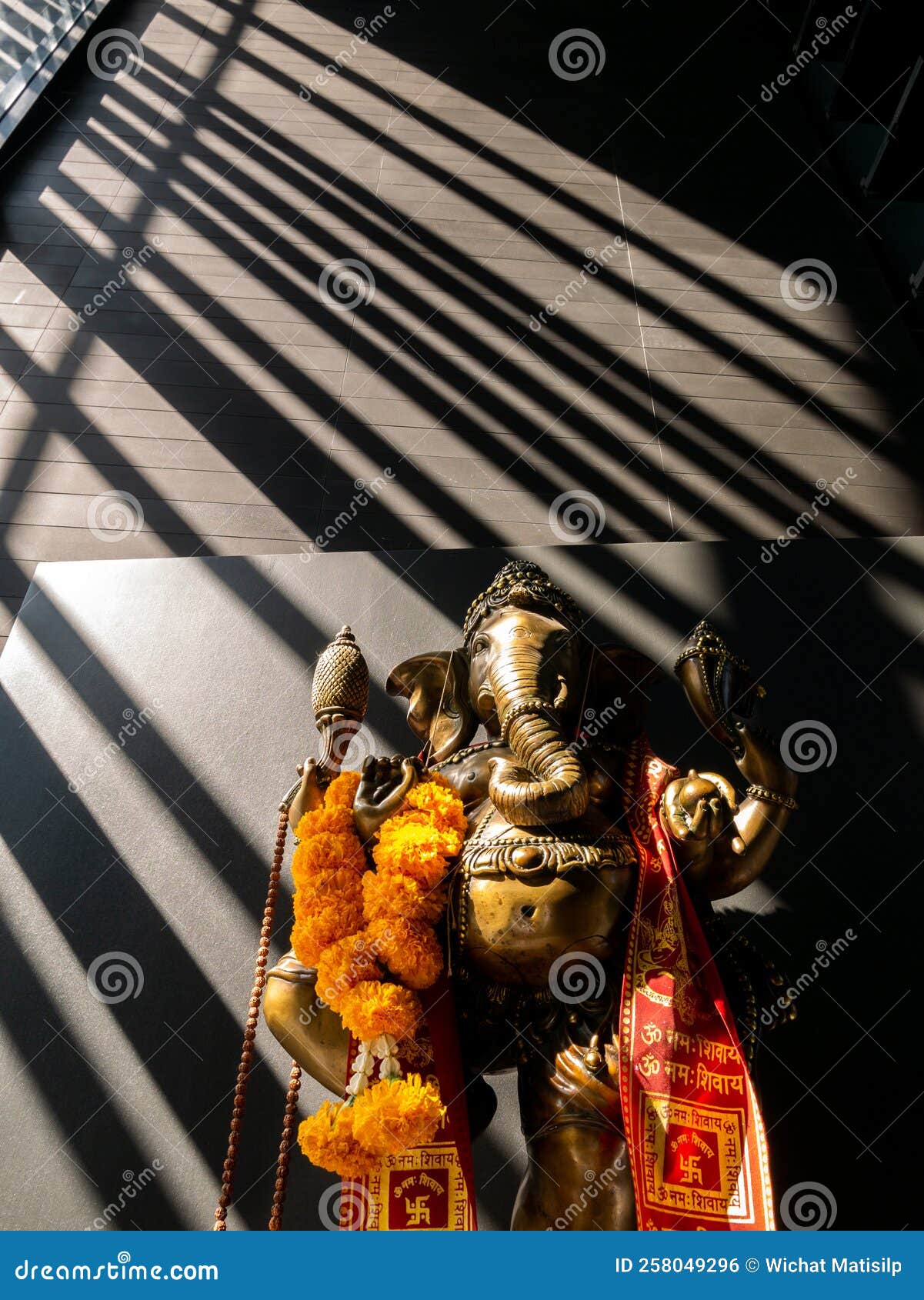 Statue of Brass Ganesha Standing Behind the Shadow Lines Stock Photo ...