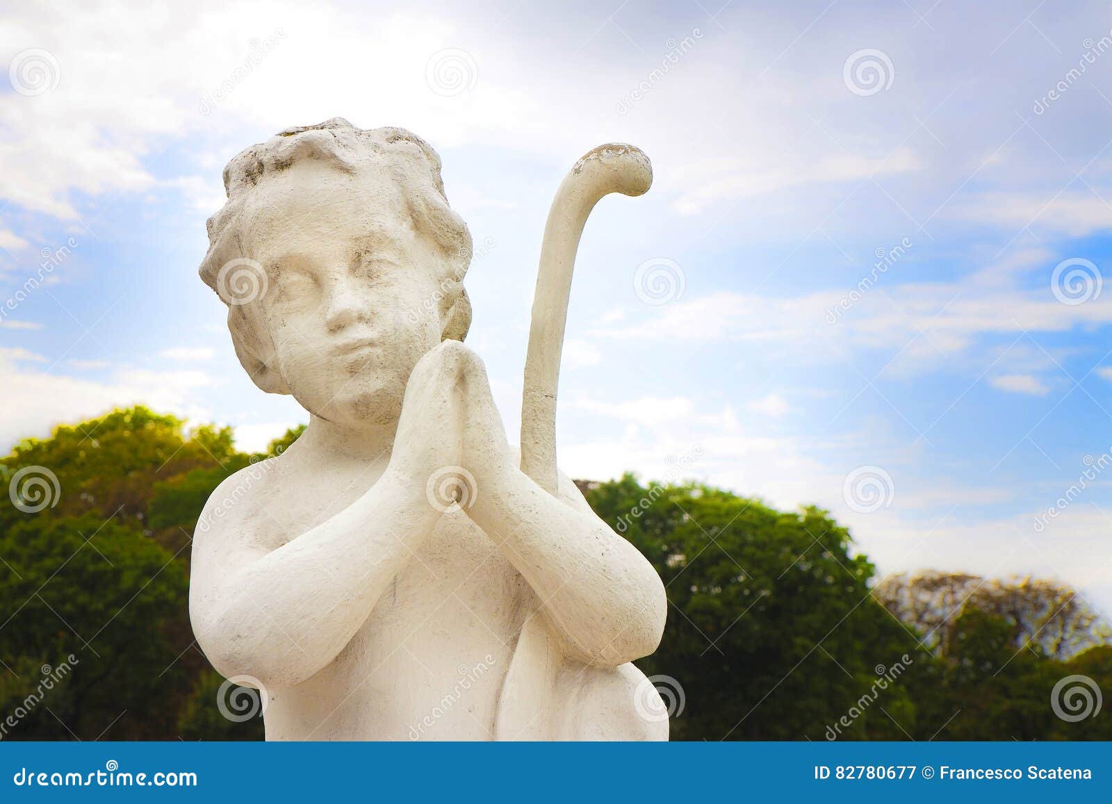 Statue of a Cherub Praying Against Blue Sky Stock Image - Image of ...