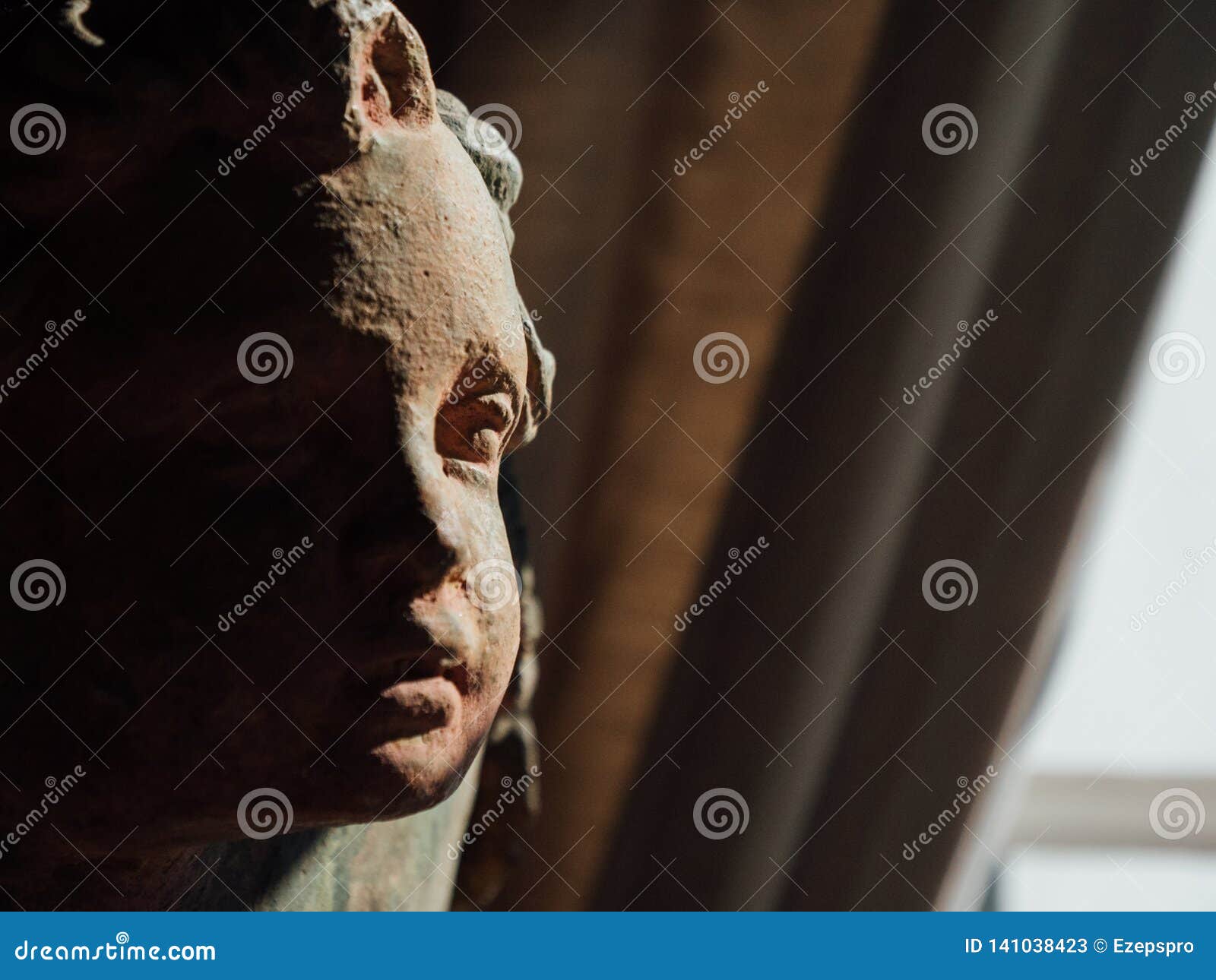 Statue with Face of Child with Half Face Illuminated Stock Image ...