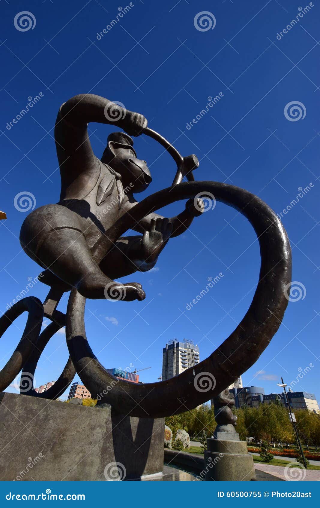 A Statue Featuring a Monkey Riding a Circus Bicycle Editorial Image ...