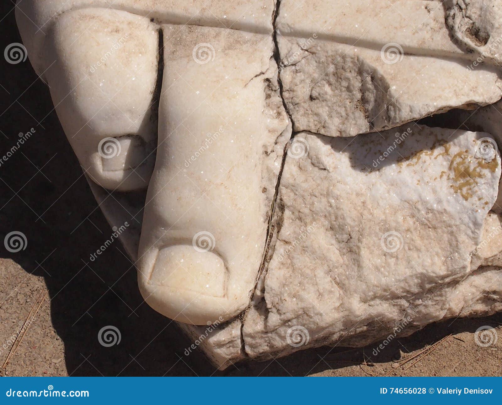 Foot. Fragment Of An Antique Marble Statue. Cracked Ground In The ...