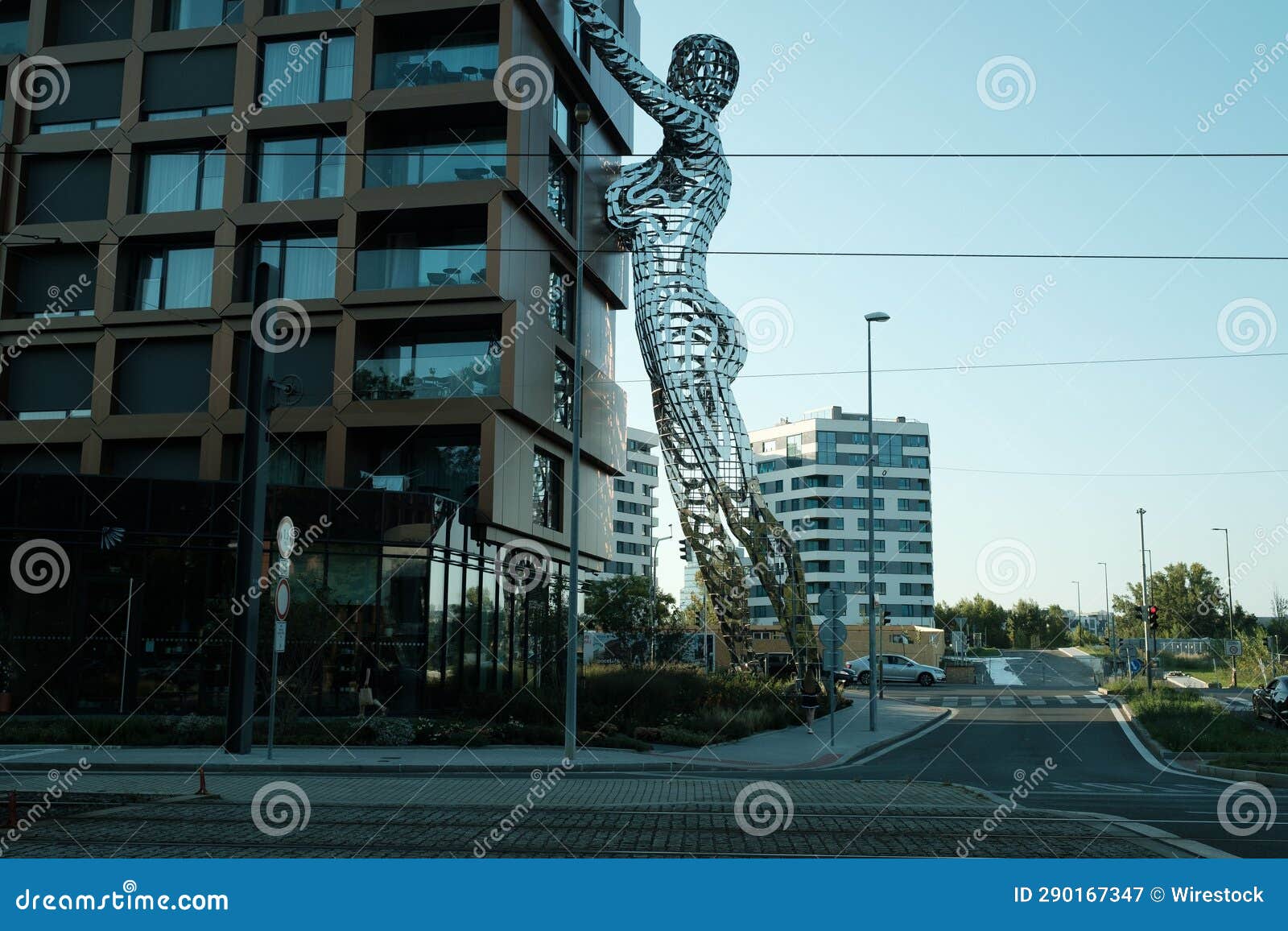 Statue of a Man Ascending a Building, Reaching Towards the Top ...