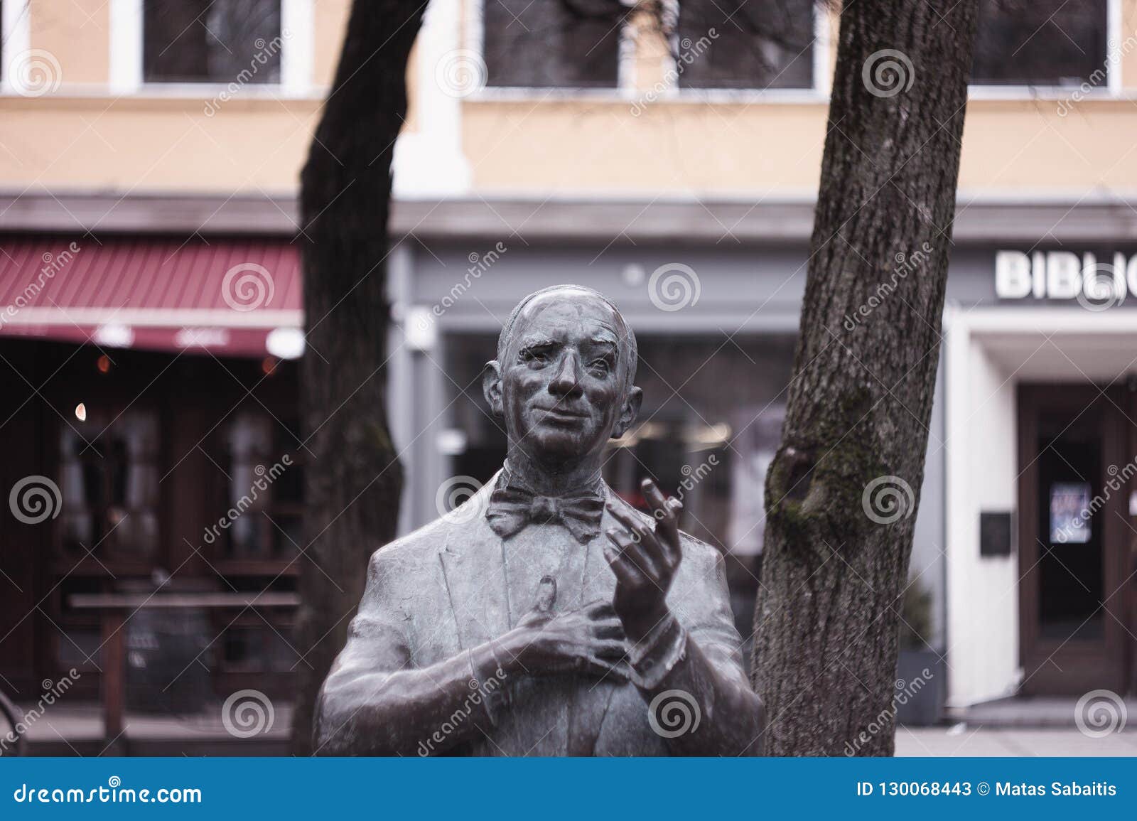Statue of Man in Public Street in Front of Two Trees Editorial Stock ...