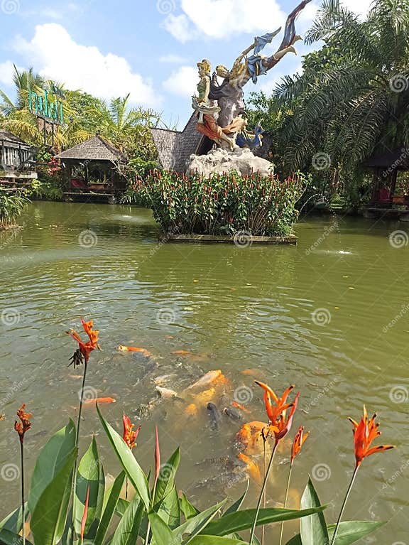 Statue in the Middle of a Fish Pond Stock Photo - Image of statue ...