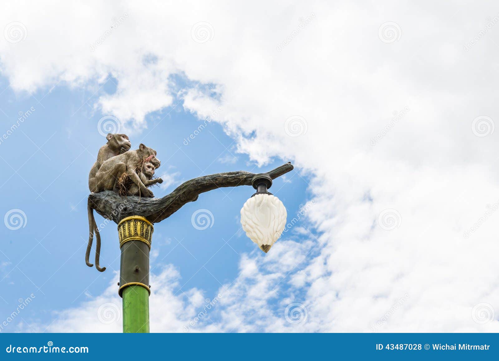 Statue Of A Monkey Family On Lamp Post On Blue Sky. Stock Photo ...