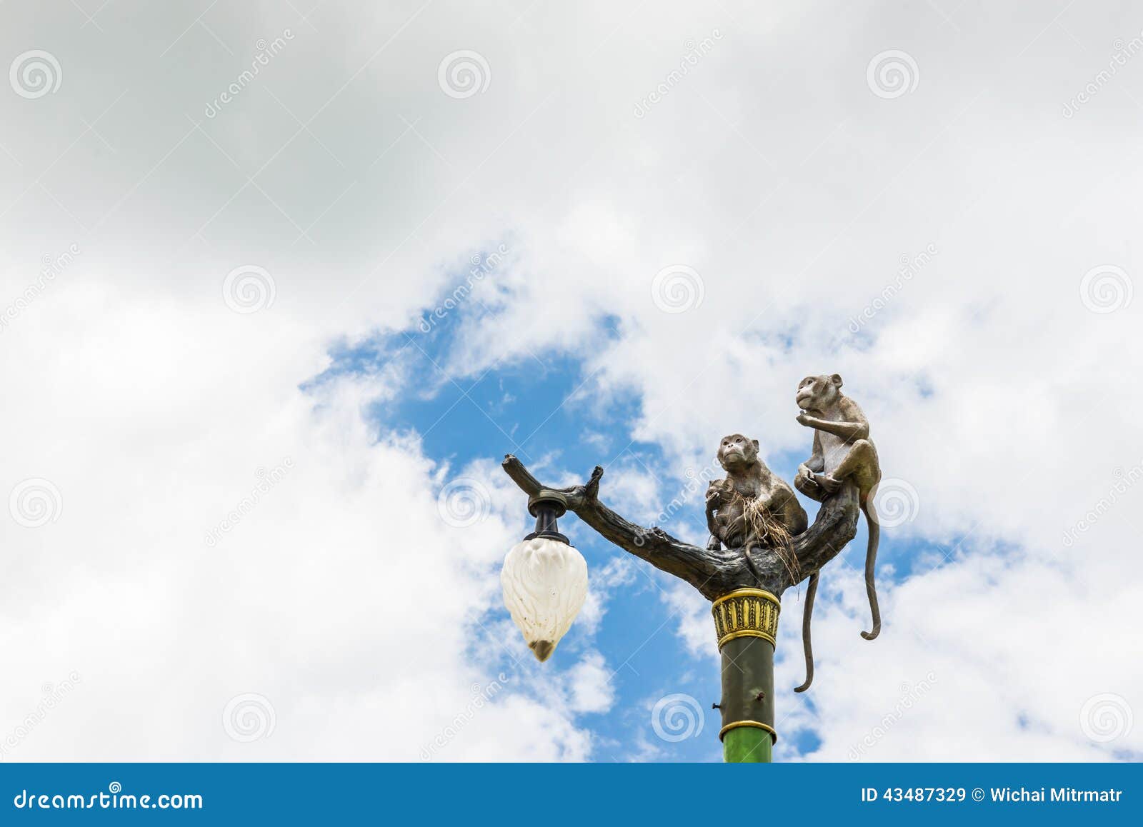 Statue Of A Monkey Family On Lamp Post On Blue Sky. Stock Image ...