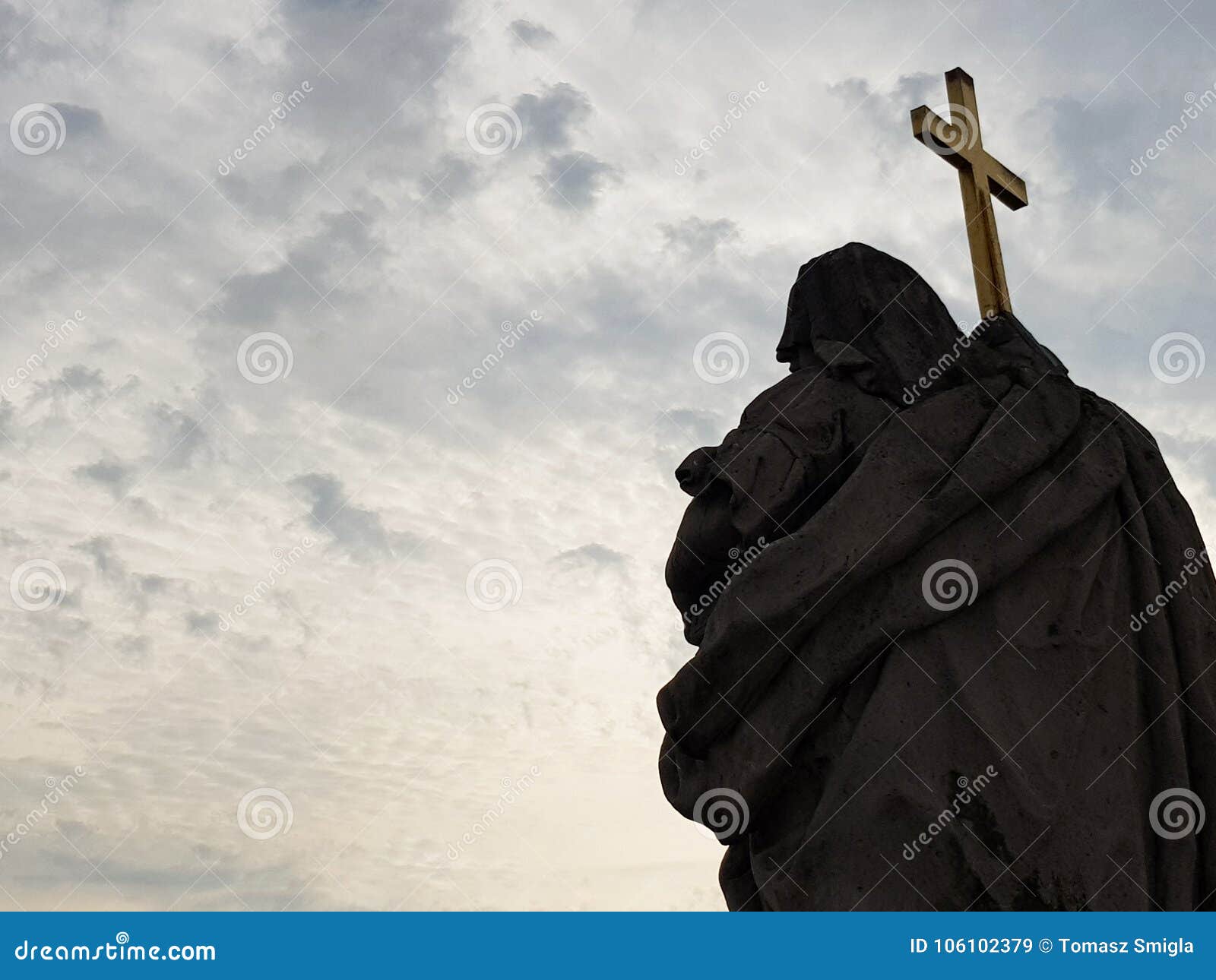 Statue of a Saint with a Cross, Sky As a Background Stock Image - Image ...