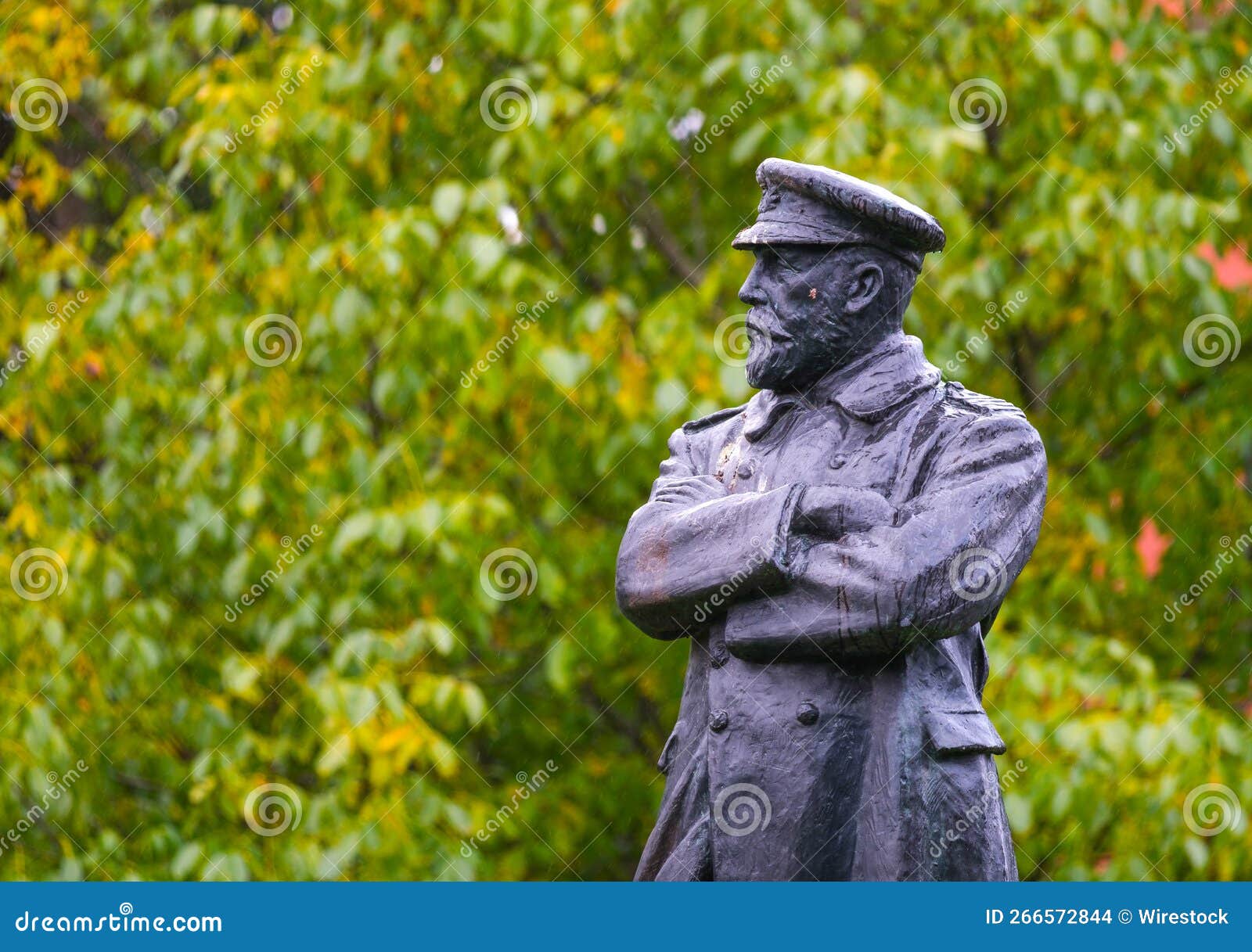 Statue To Commander Edward John Smith on the Background of Green Trees ...