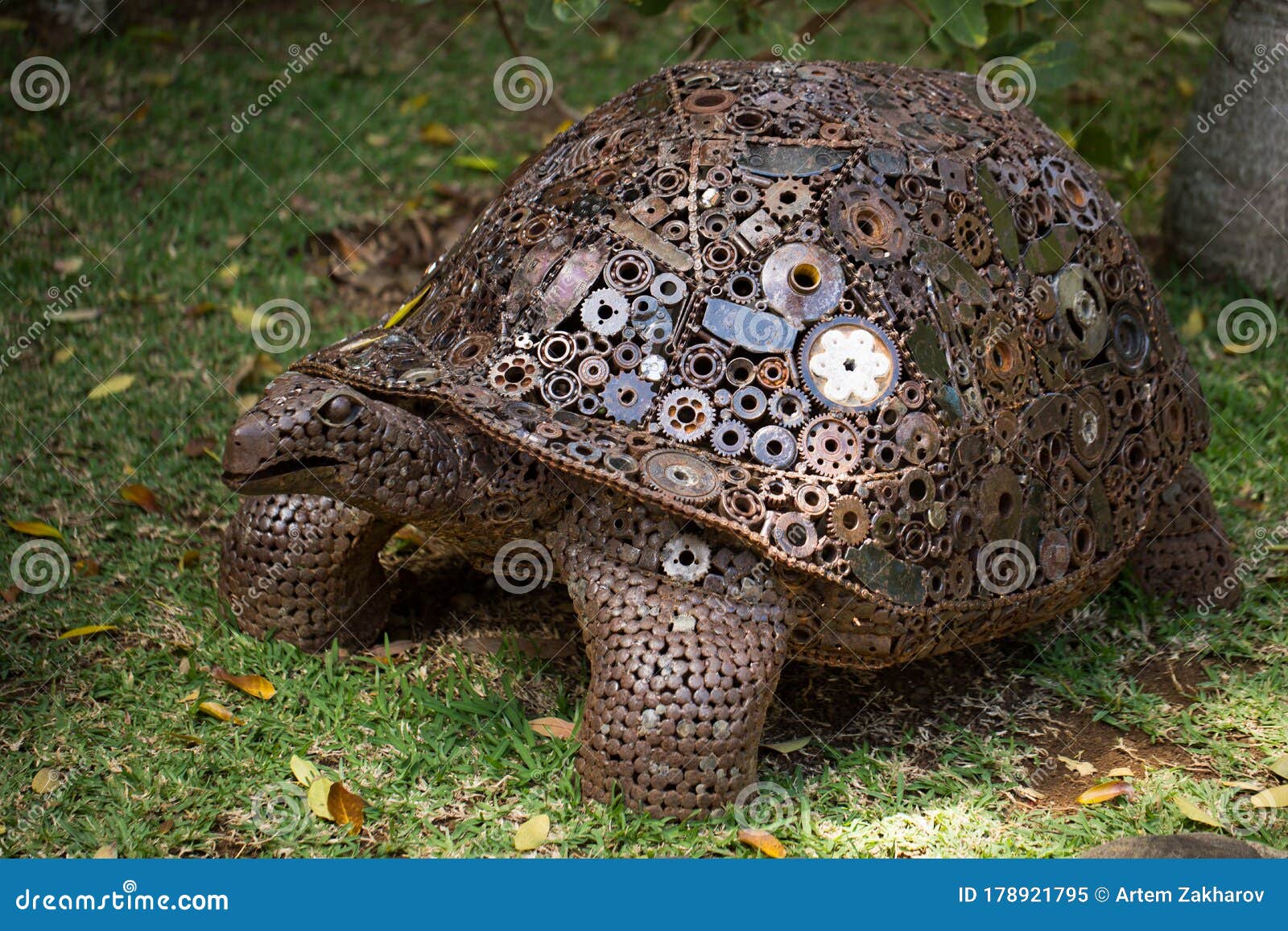 A Turtle Made Of Metal Stands On A Stone At The Entrance To The Park ...