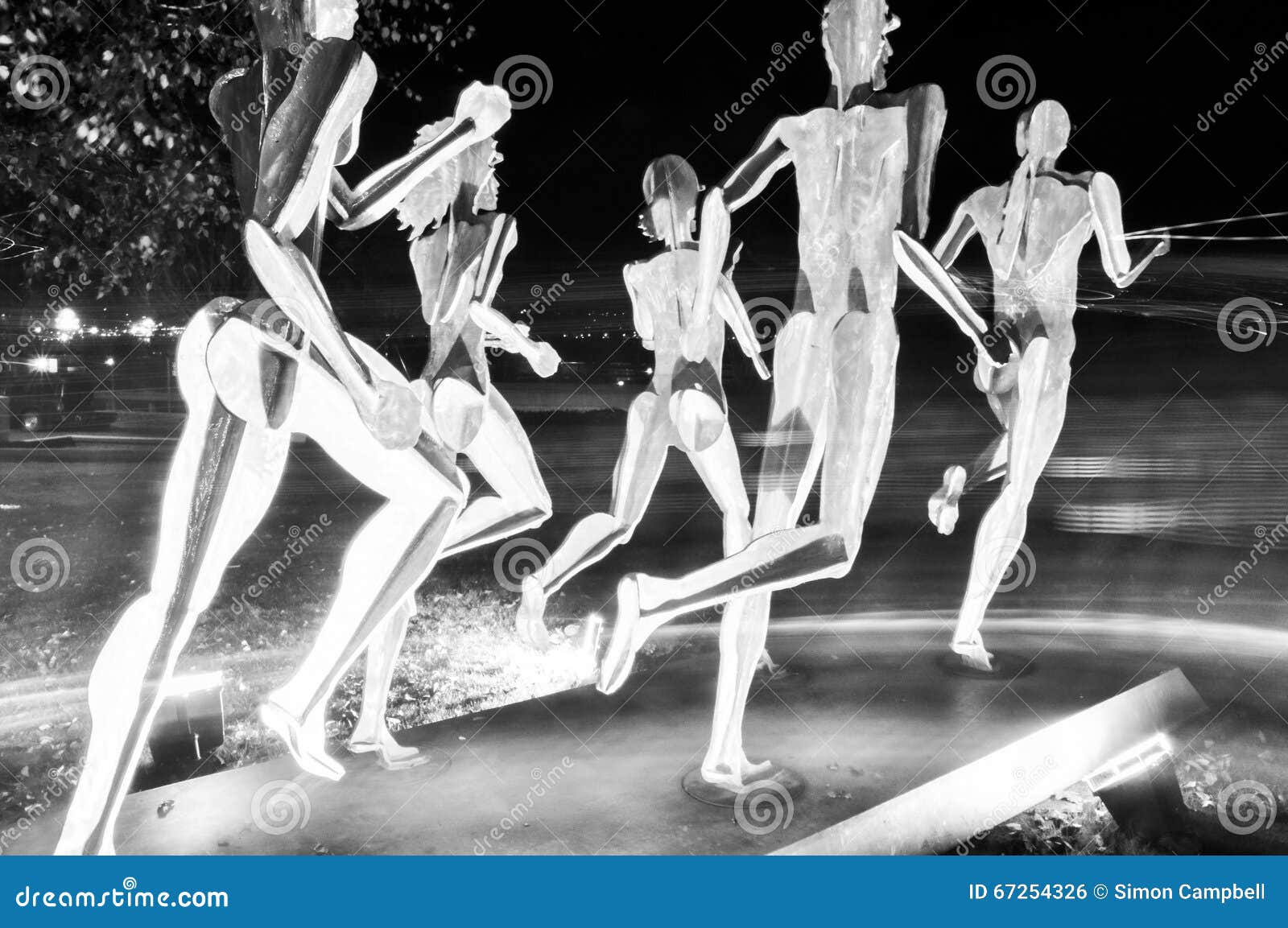 Statues lit at night stock photo. Image of silhouette - 67254326