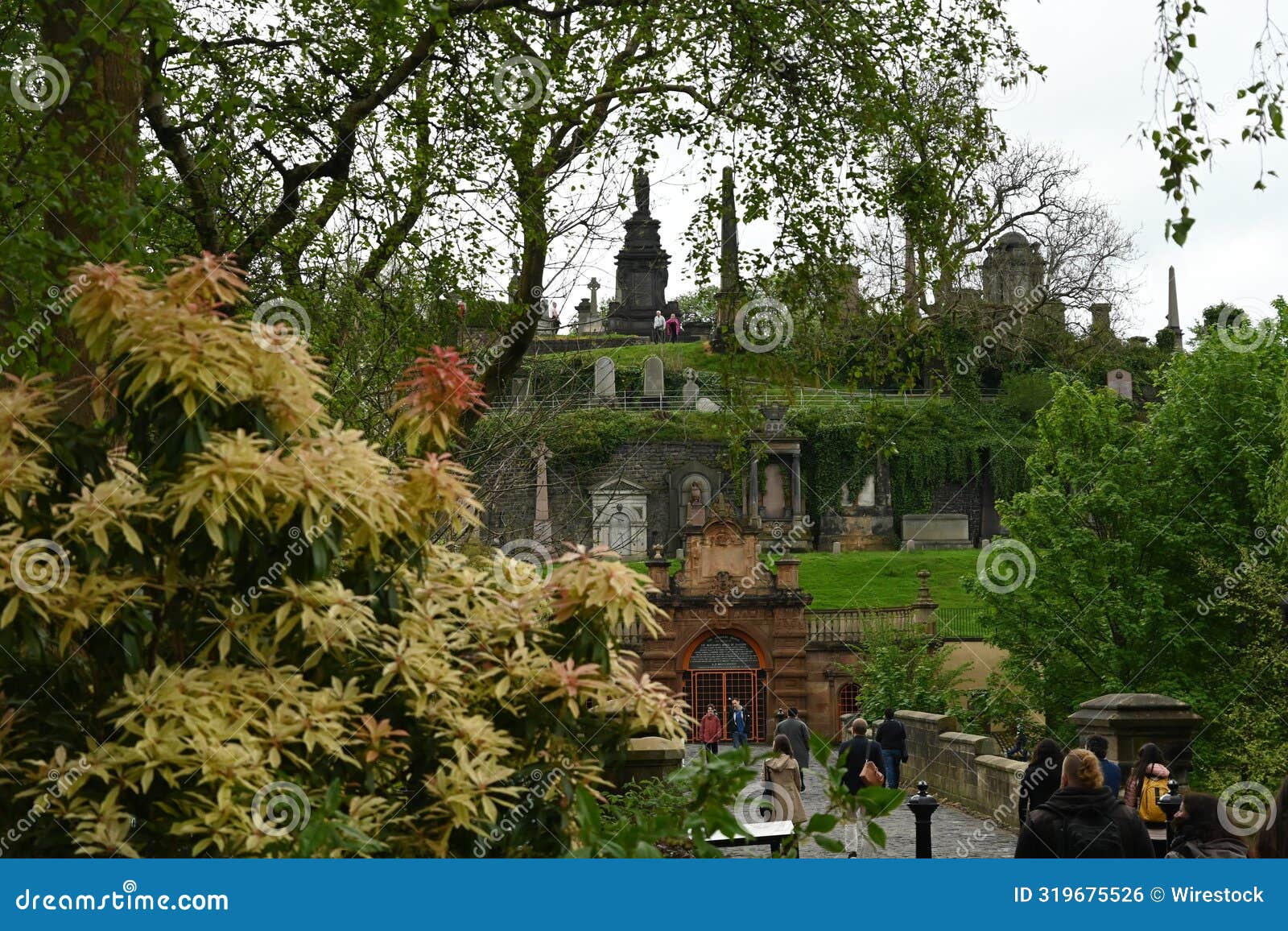 Statues in Park with People on Pathway Stock Photo - Image of ...