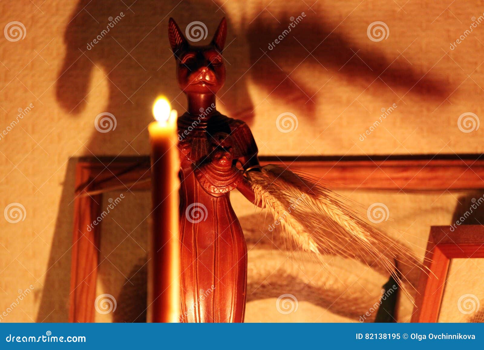 Statuette of the Goddess Bastet and Ritual Candle on the Altar. Stock ...