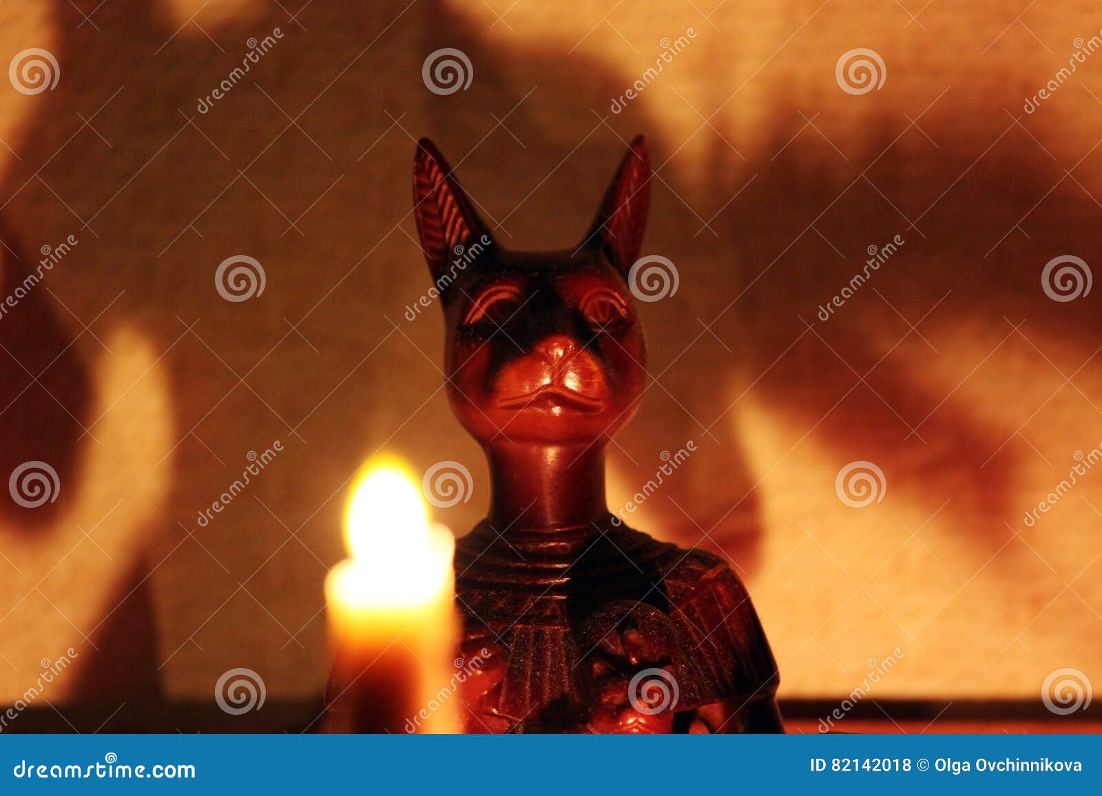 Statuette of the Goddess Bastet and Ritual Candle on the Altar. Stock ...