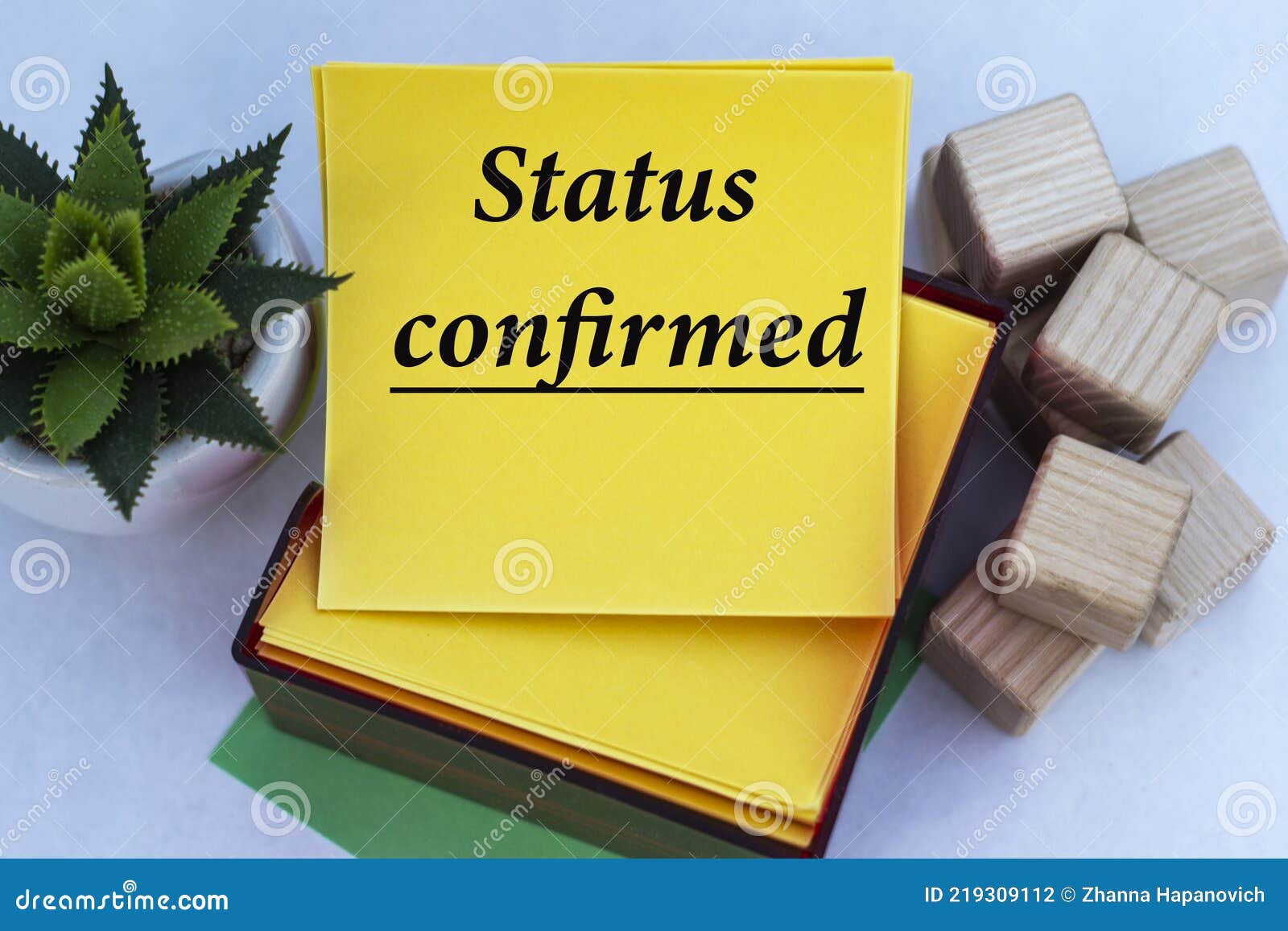 STATUS CONFIRMED - Words on a Yellow Note Paper on a Light Background ...