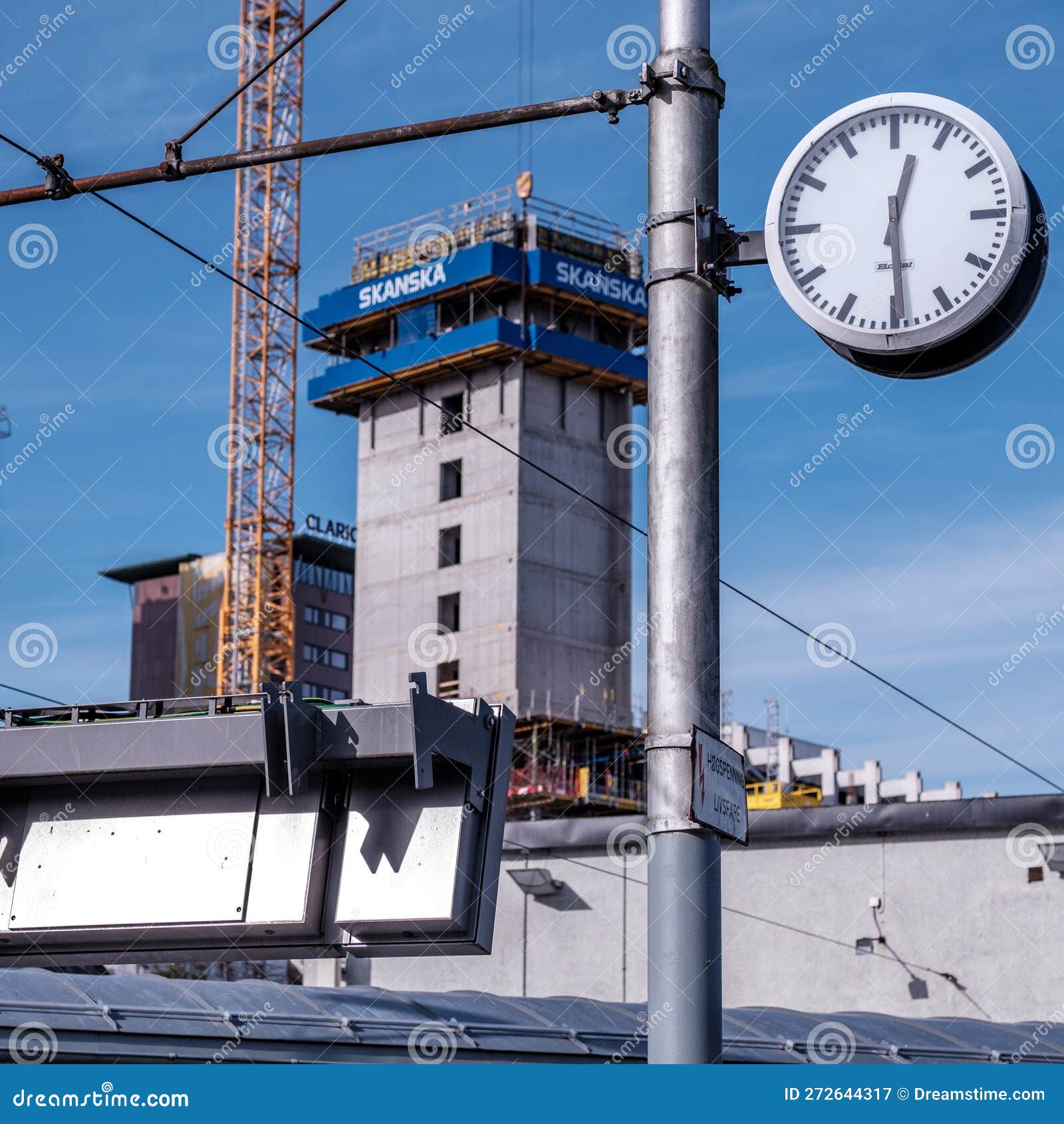 Large Outside Clock and Work on a High Rise Tower Block Development ...
