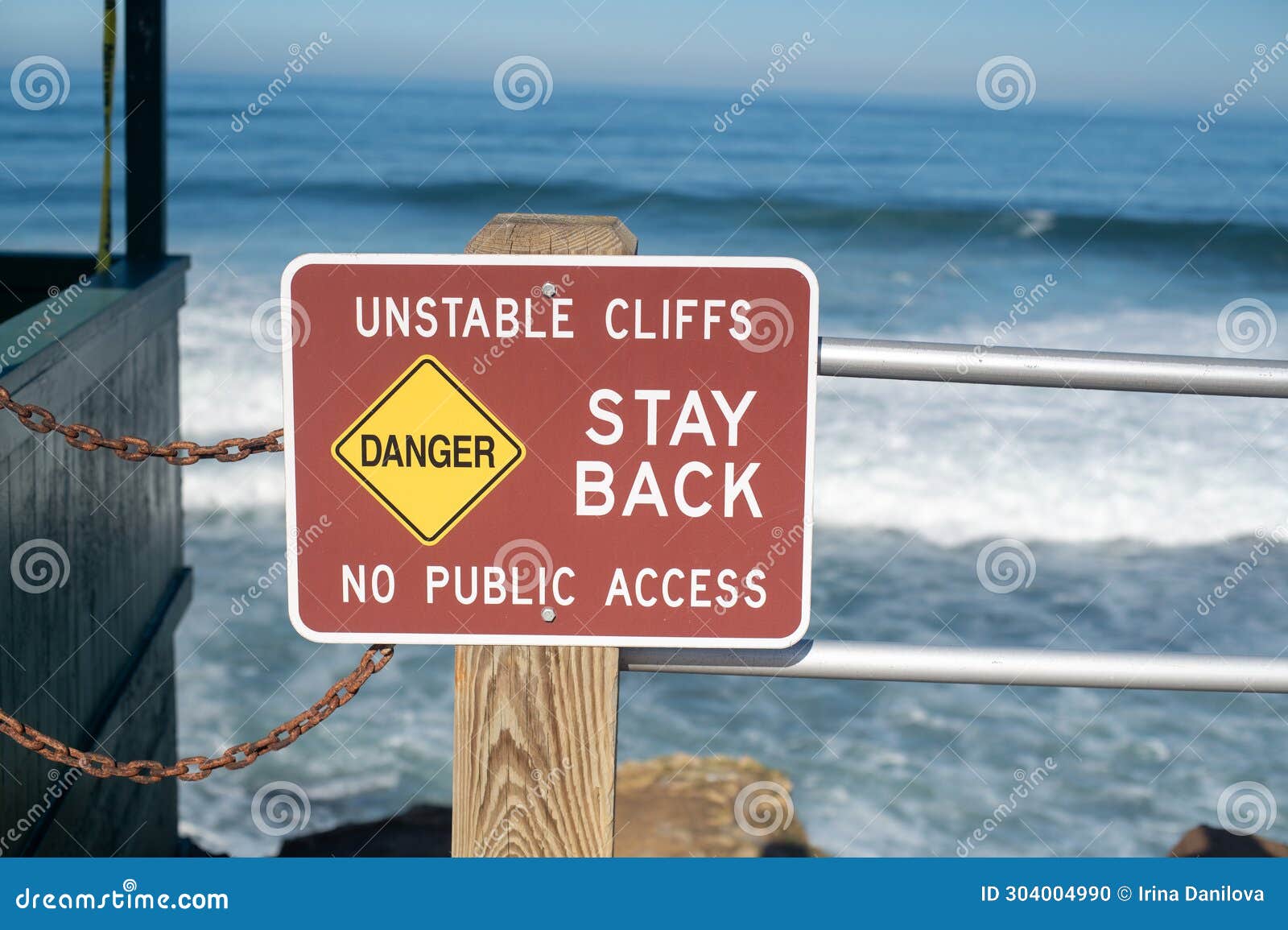 Stay back sign on a beach stock photo. Image of water - 304004990