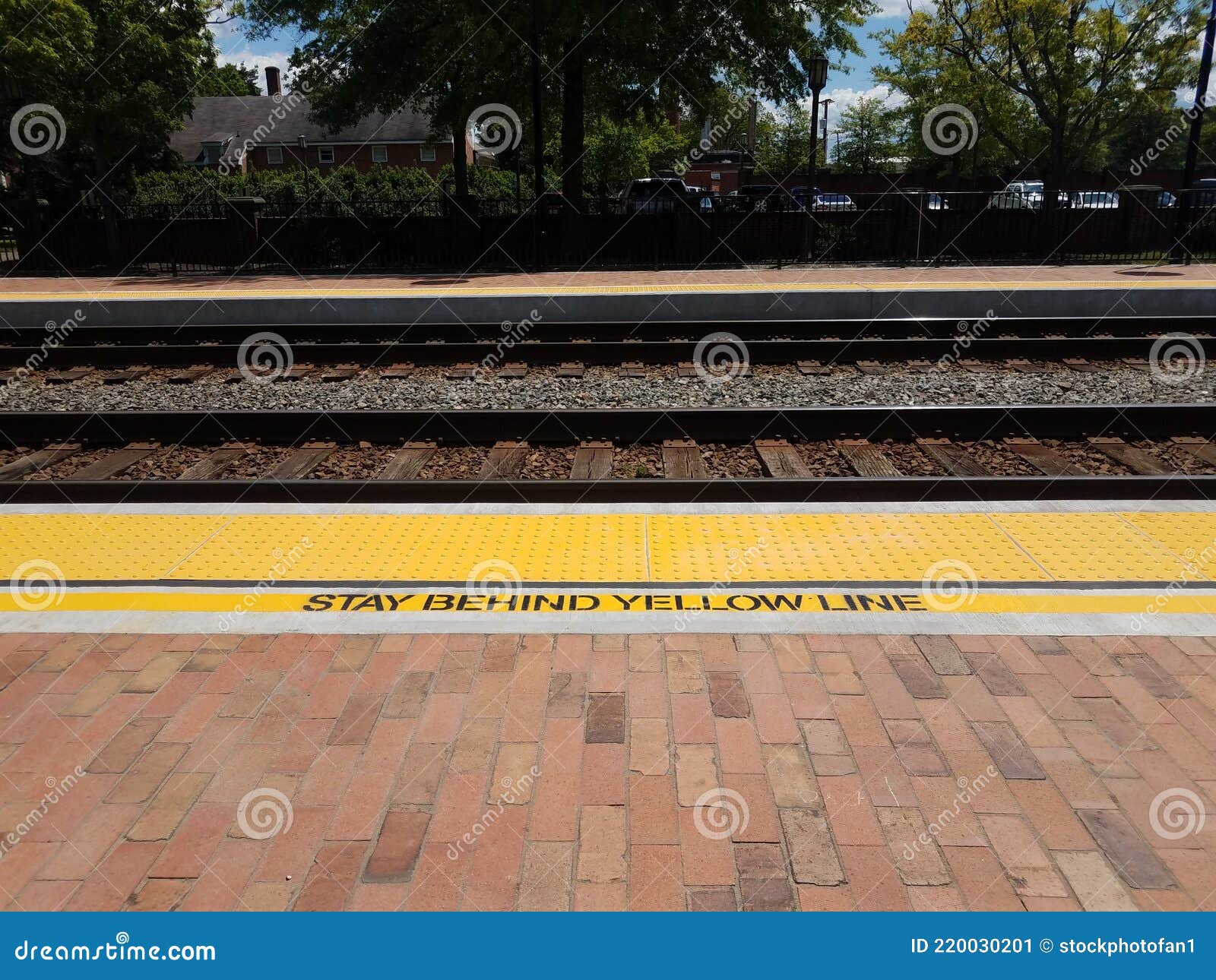 Stay Behind Yellow Line Sign and Train Tracks Stock Image - Image of ...