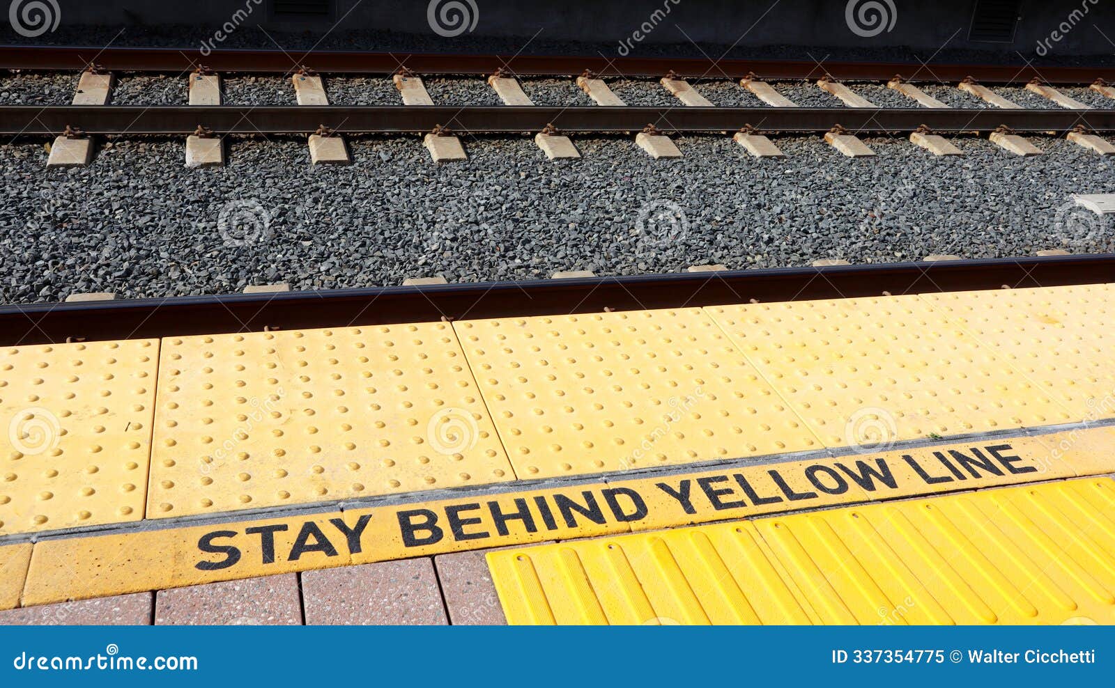 Stay Behind Yellow Line Warning Sign on Platform at Train Station Stock ...