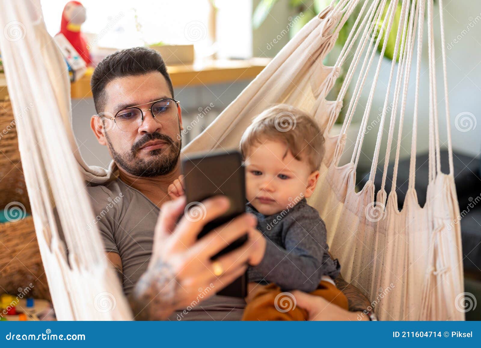 Stay at Home Dad on Smartphone Ignoring Child Stock Photo - Image of ...