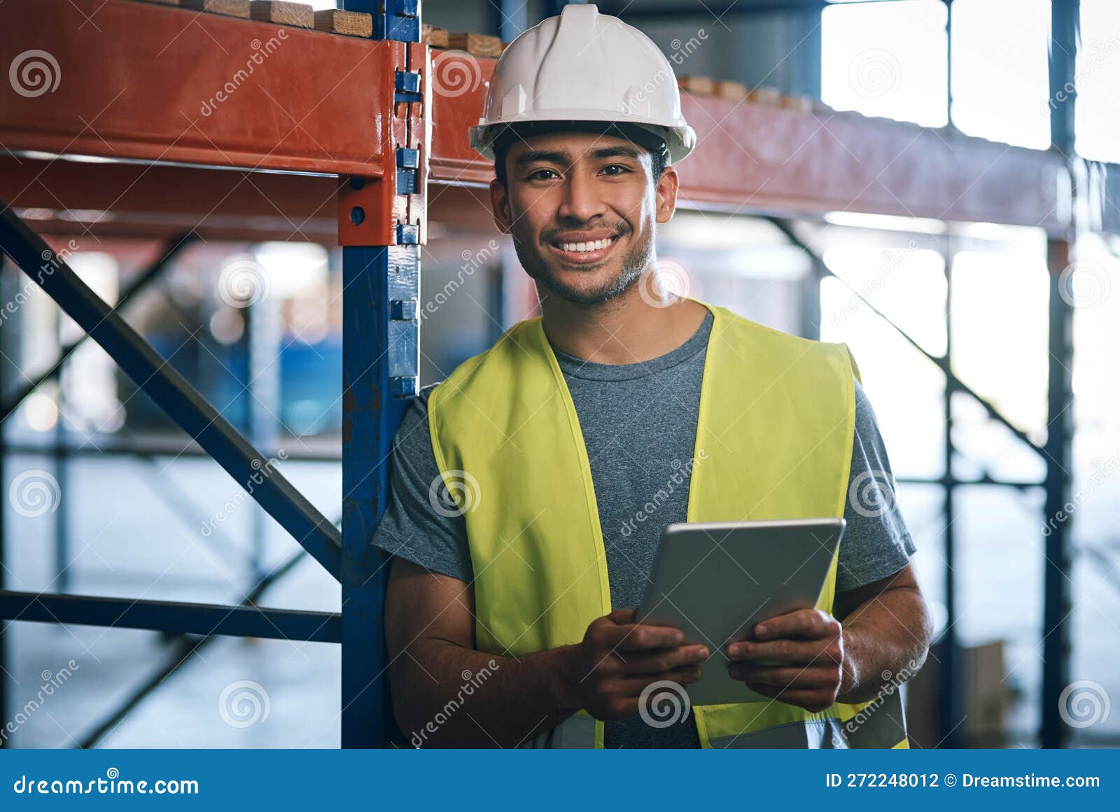 Stay Informed, Stay Safe. a Builder Using a Digital Tablet while ...