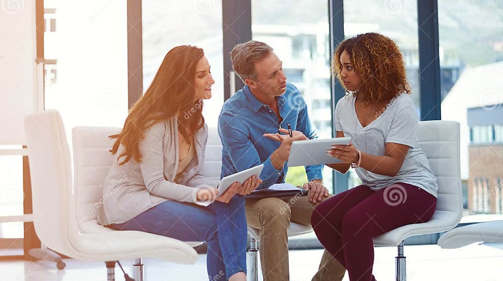 Staying Informed As a Team. a Creative Team Using a Digital Tablet ...