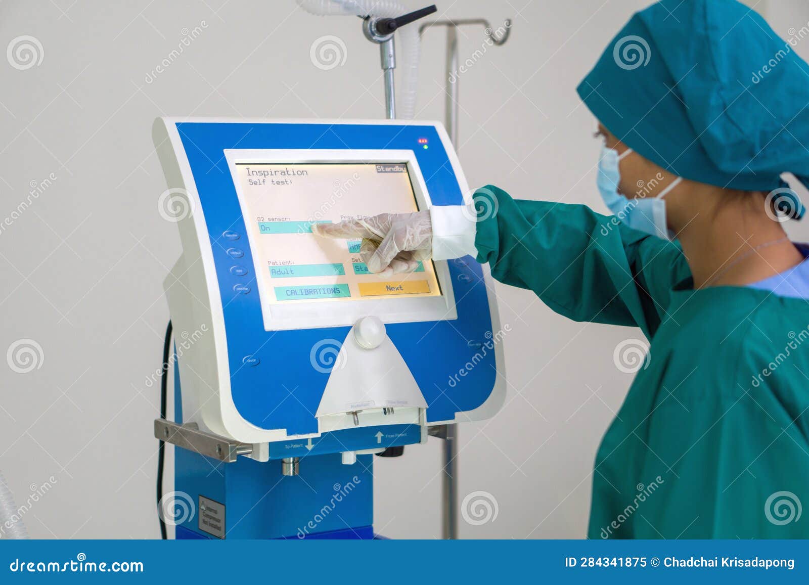 A Steadfast Surgeon, Garbed in Sterile Surgical Attire, is Expertly Operating an Advanced ...