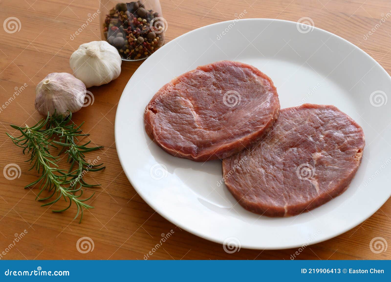 Steak on a Plate Ready To Be Made Stock Image - Image of garlic ...
